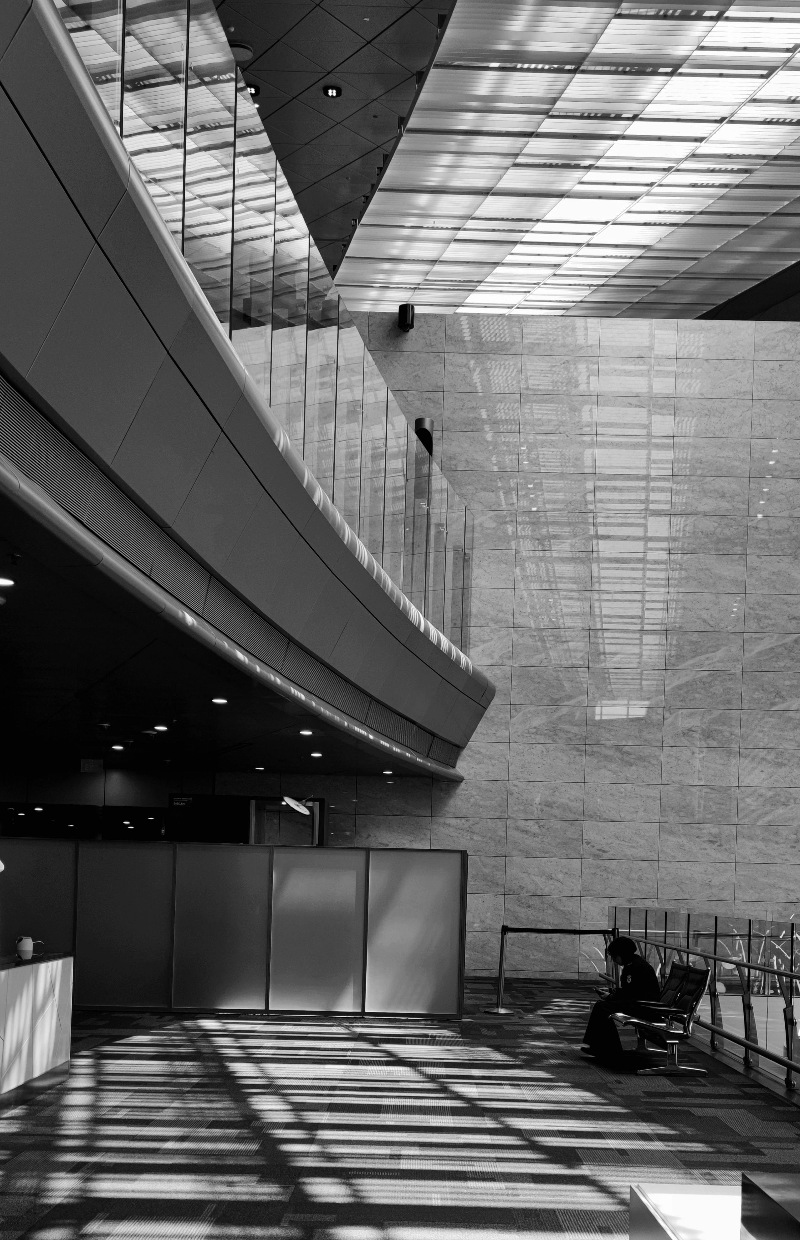Person Sitting in a Waiting Room of a Modern Building · Free Stock Photo