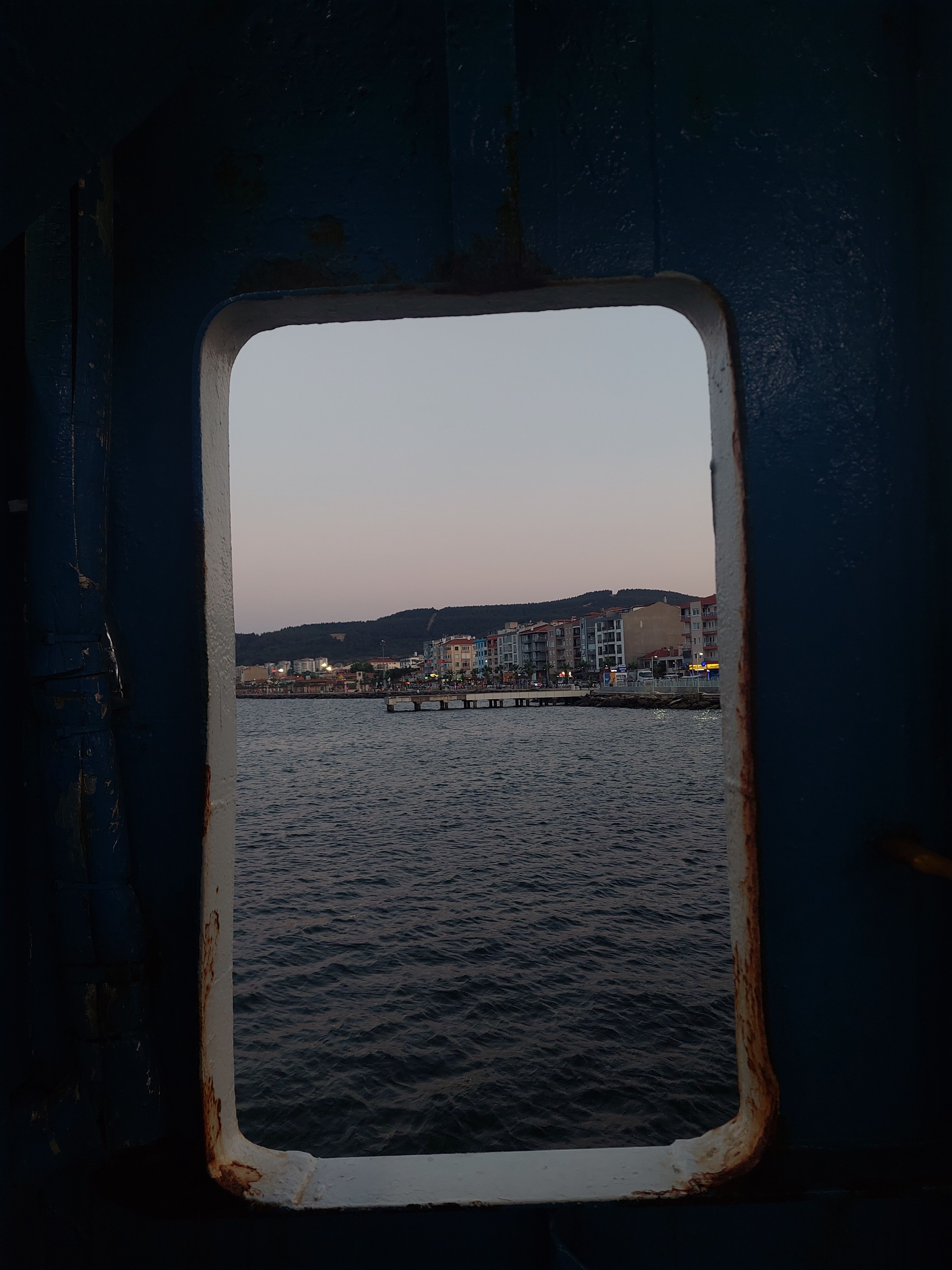 Coastal Town seen through a Rectangular Window at Dusk · Free Stock Photo