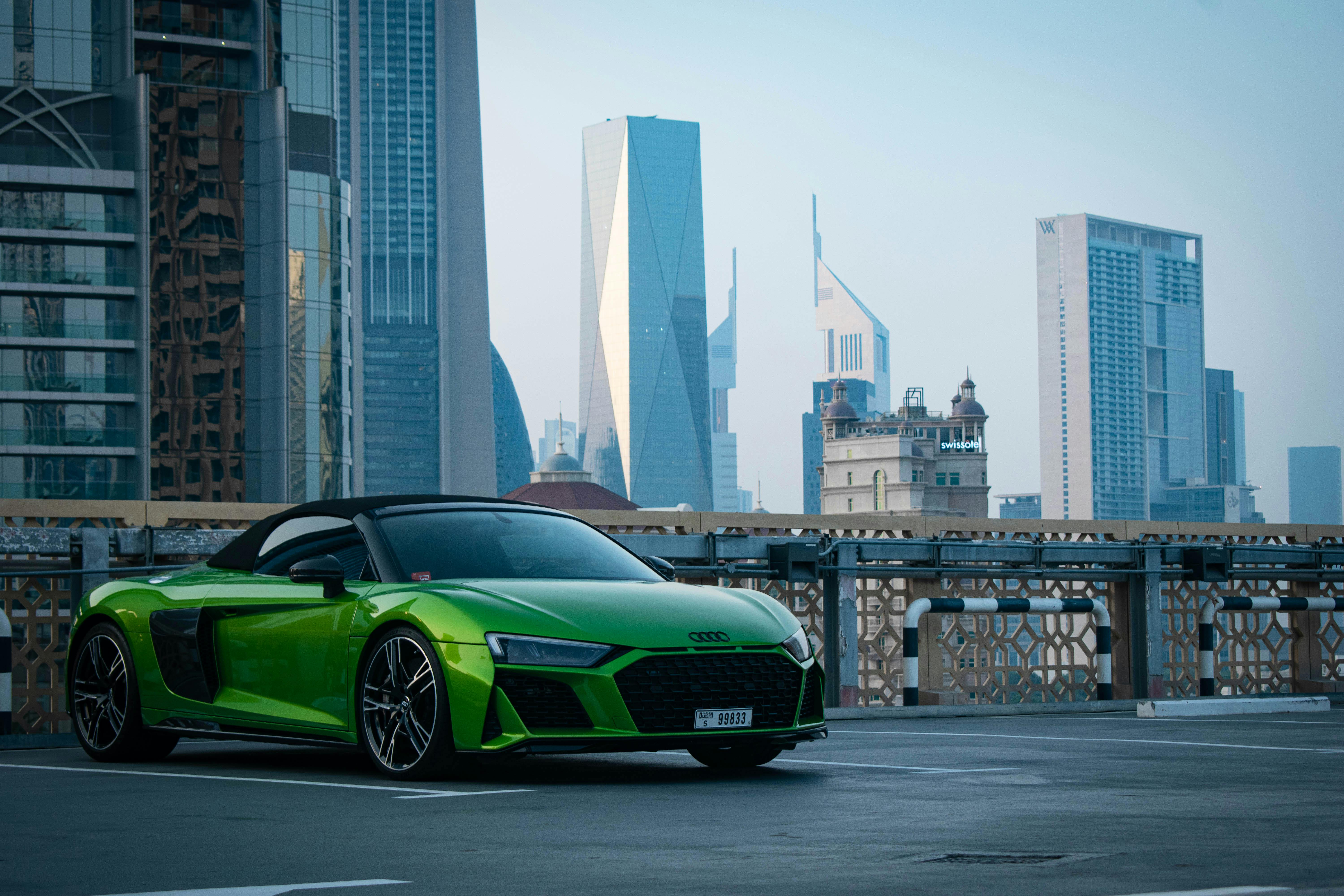 City Skyscrapers behind Green Audi R8 · Free Stock Photo