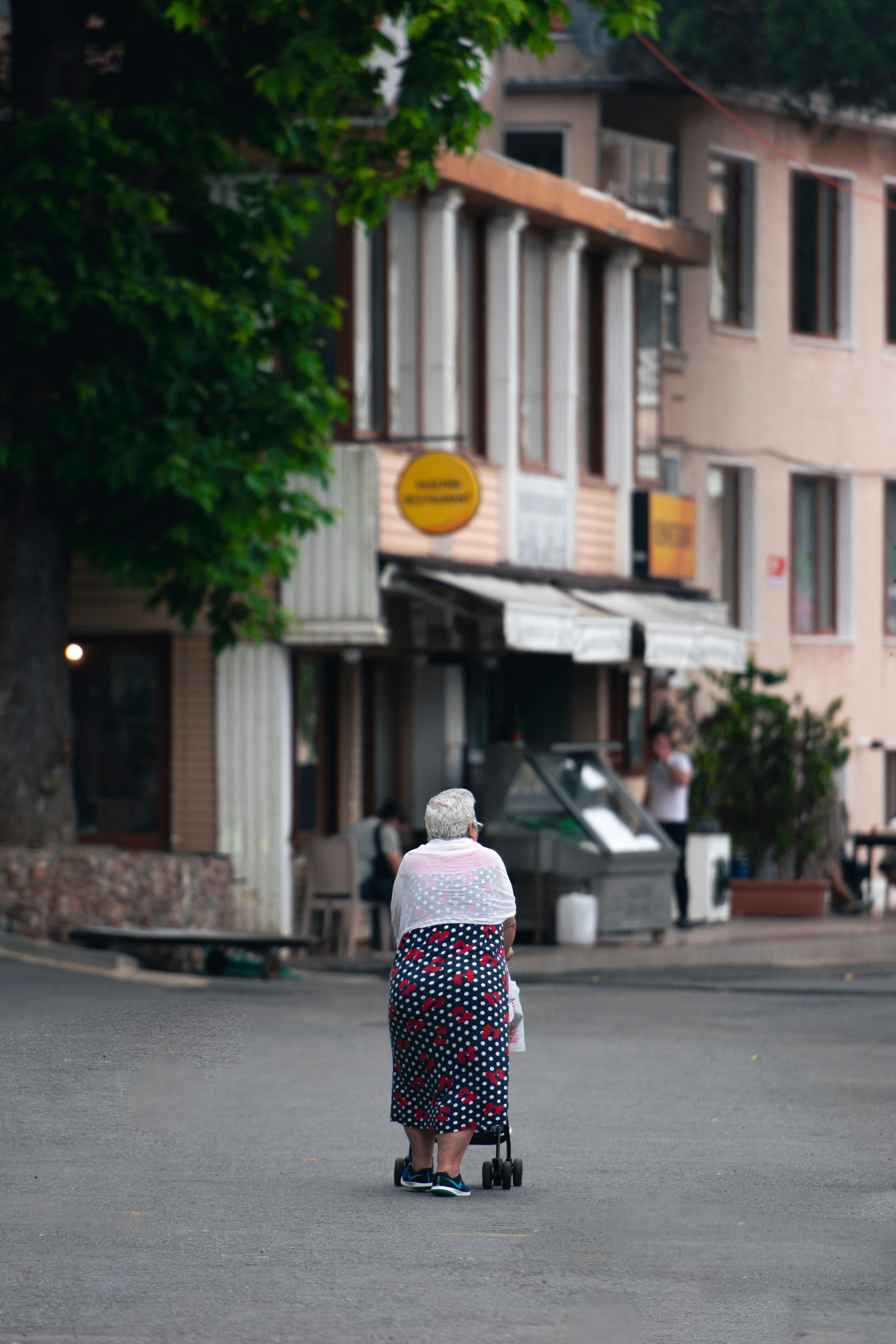 Woman Walking Betweeen Buildings · Free Stock Photo