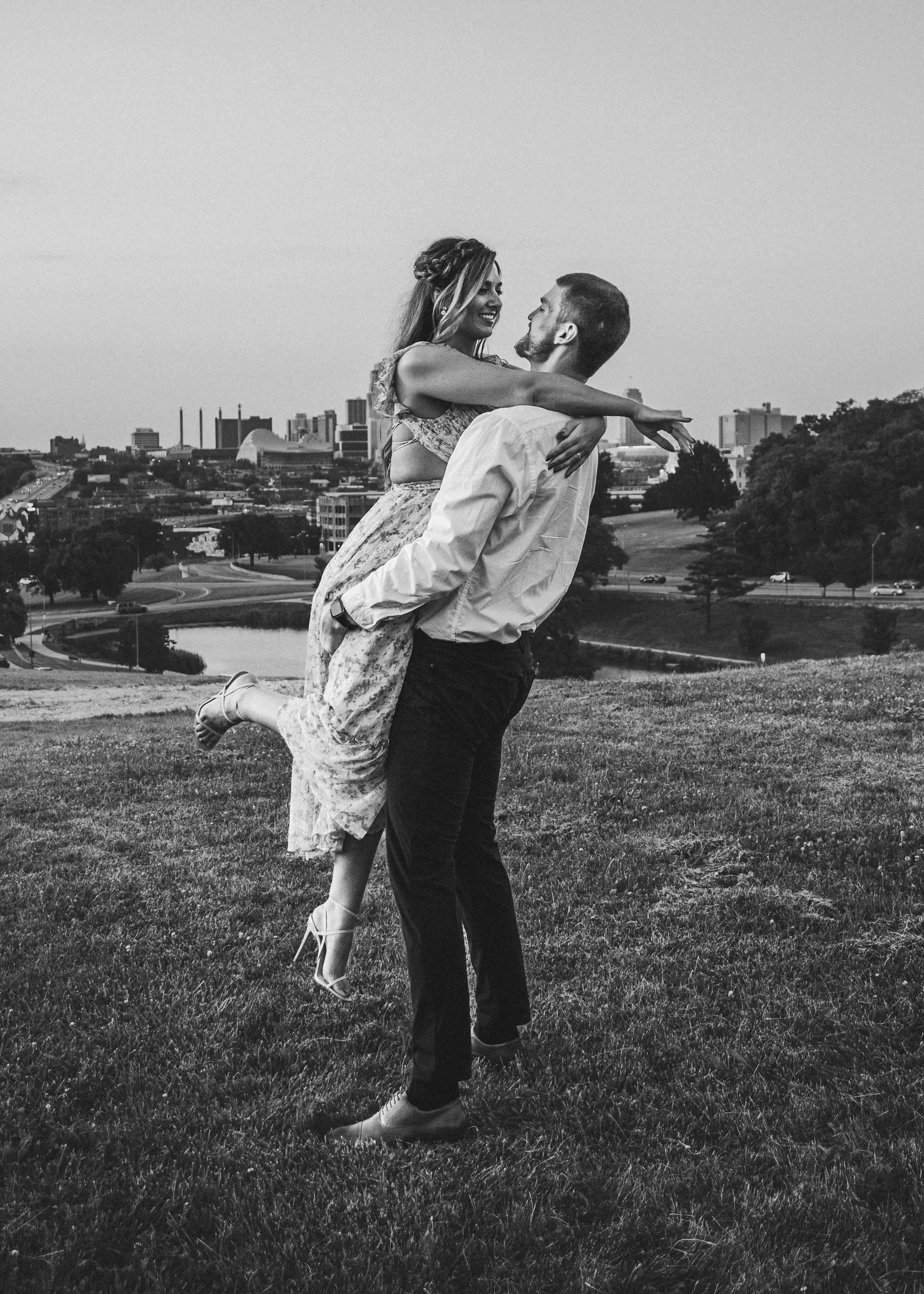 Grayscale Shot of a Man Picking Up his Partner · Free Stock Photo