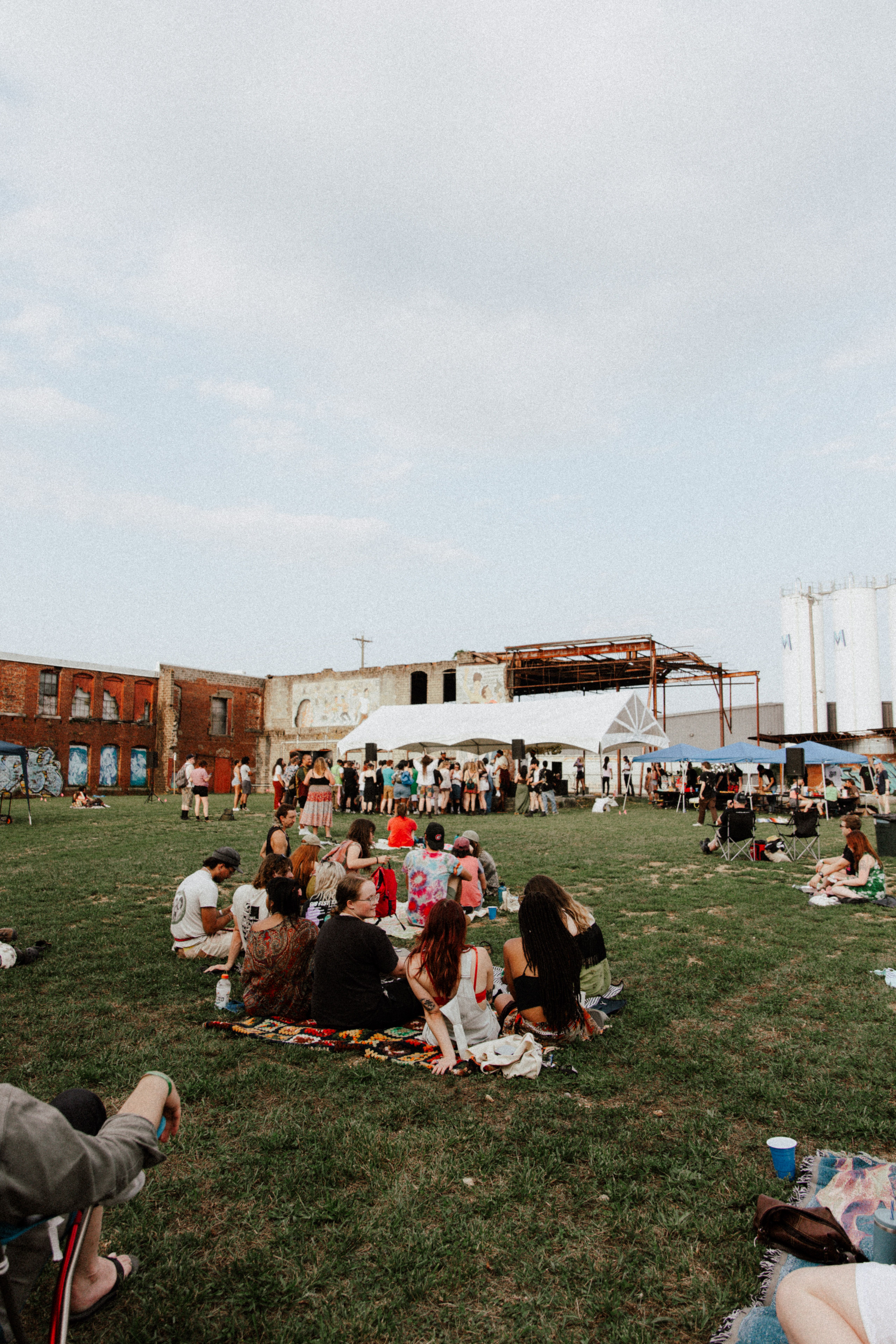People Sitting on Grass on Square on Concert in Town · Free Stock Photo