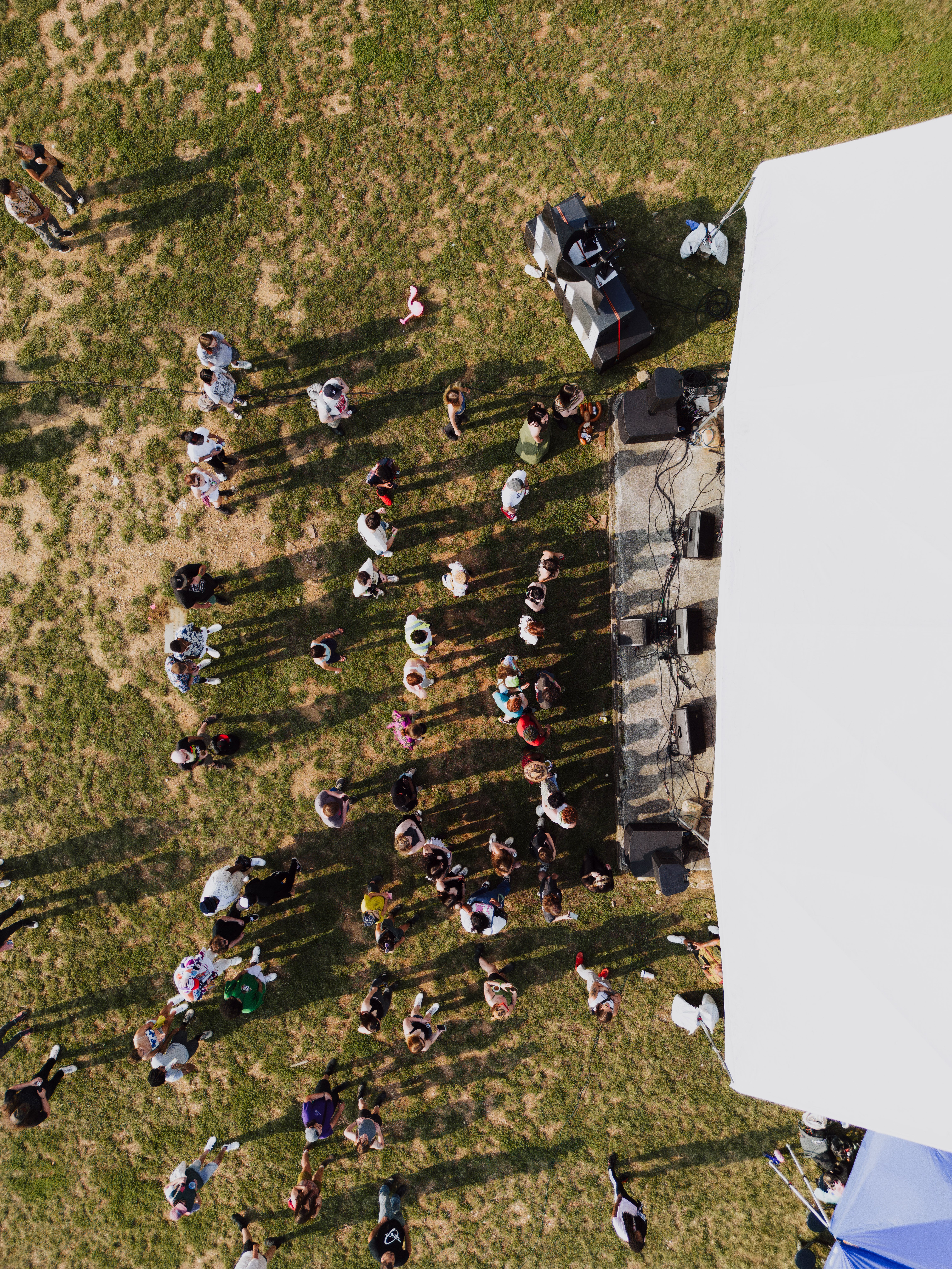 People Standing on Grass near Concert Stage · Free Stock Photo