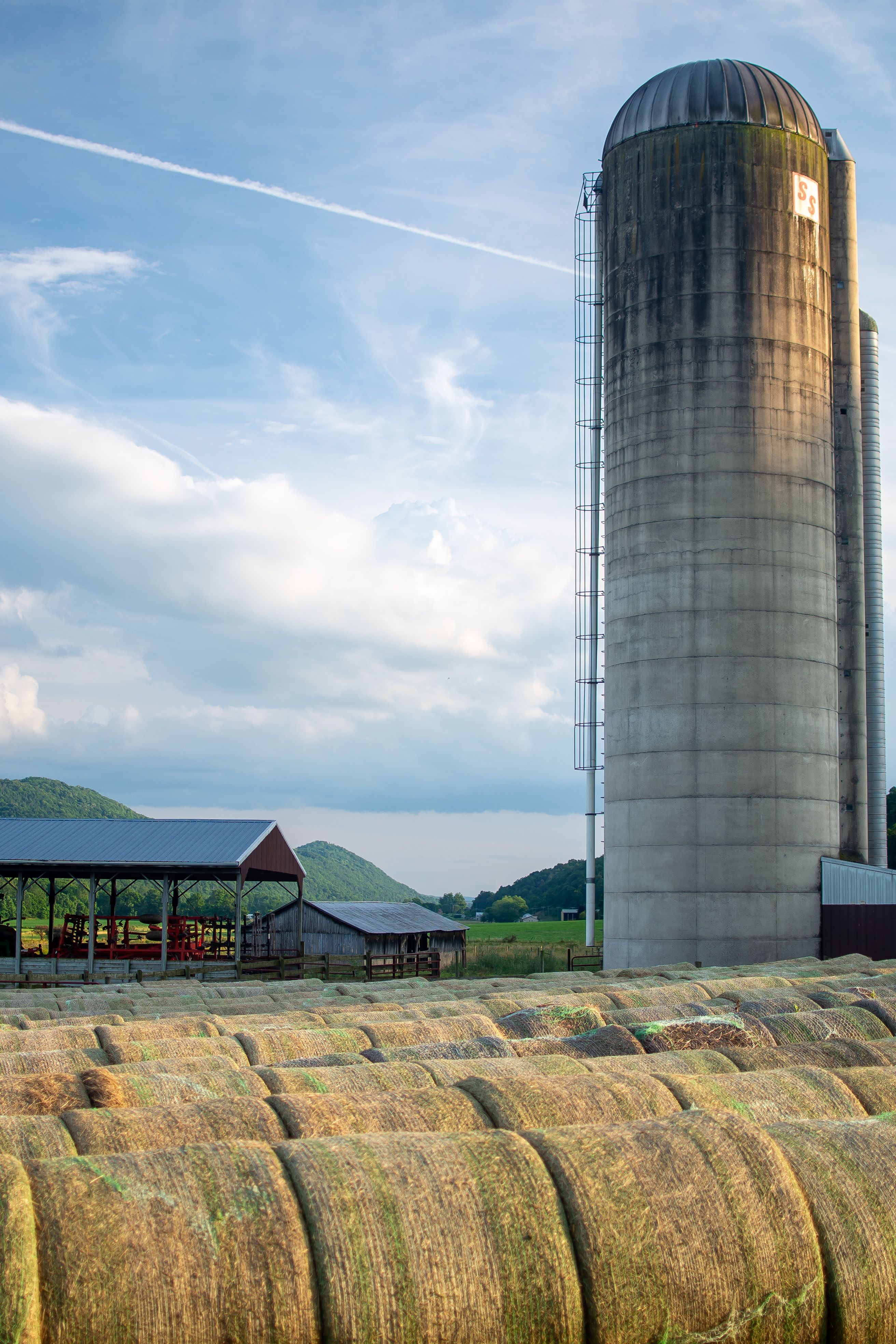 Bales of Hay on the Farm Next to the Grain Silo · Free Stock Photo