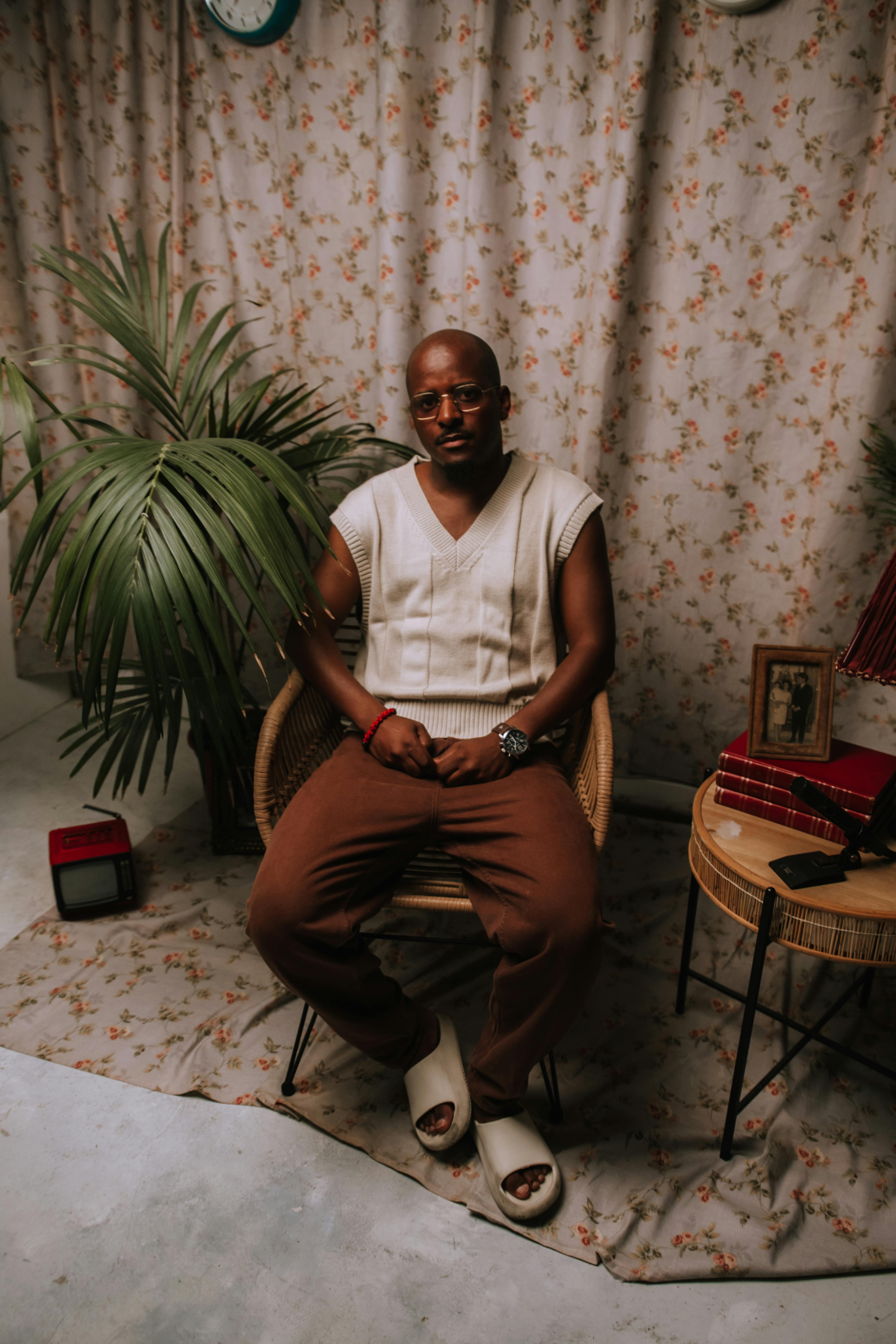 Man Sitting on Chair in Sleeveless Sweater and Flip Flops · Free Stock ...