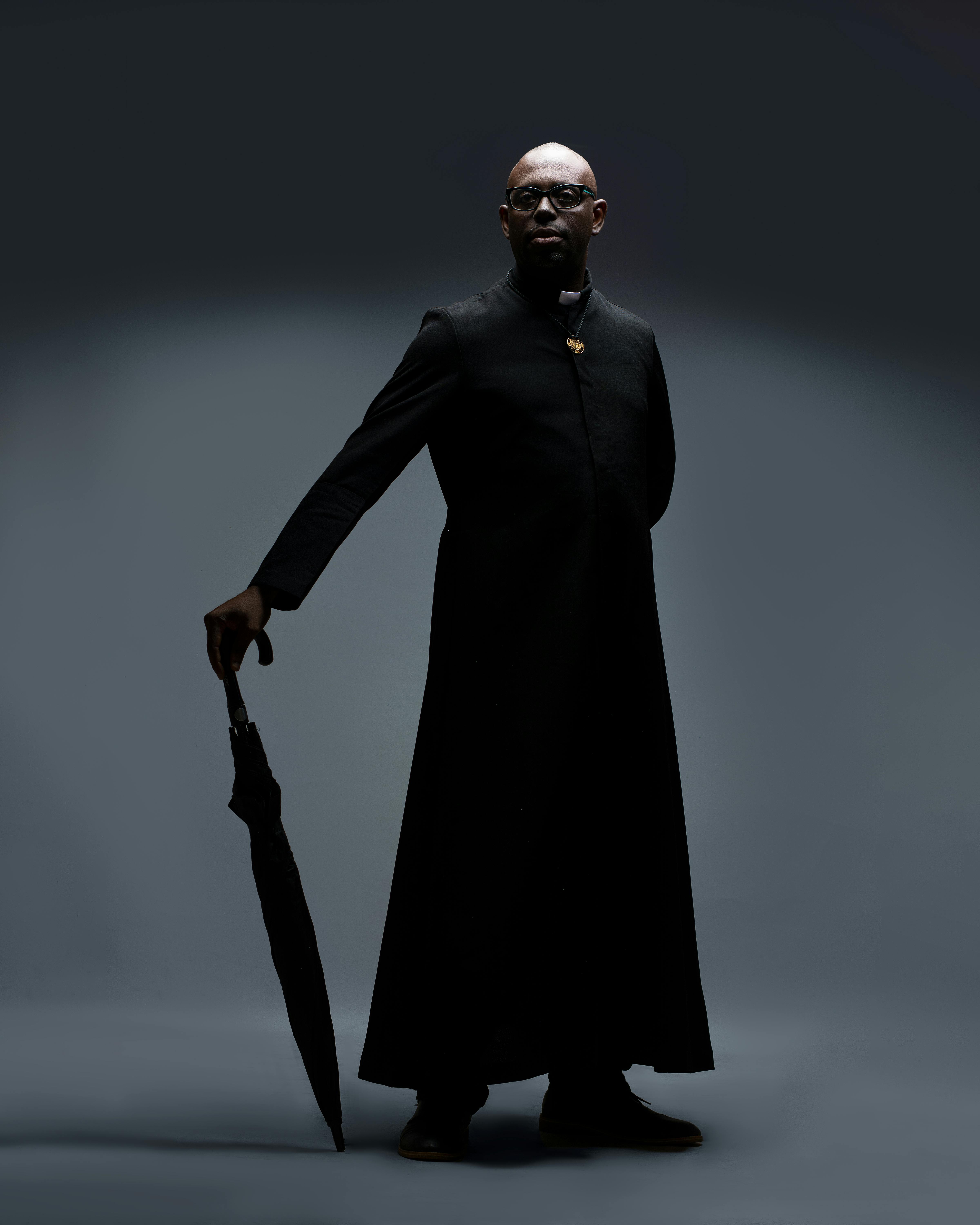 A Priest in a White Habit Wearing a Rosary and Holding a Book · Free ...