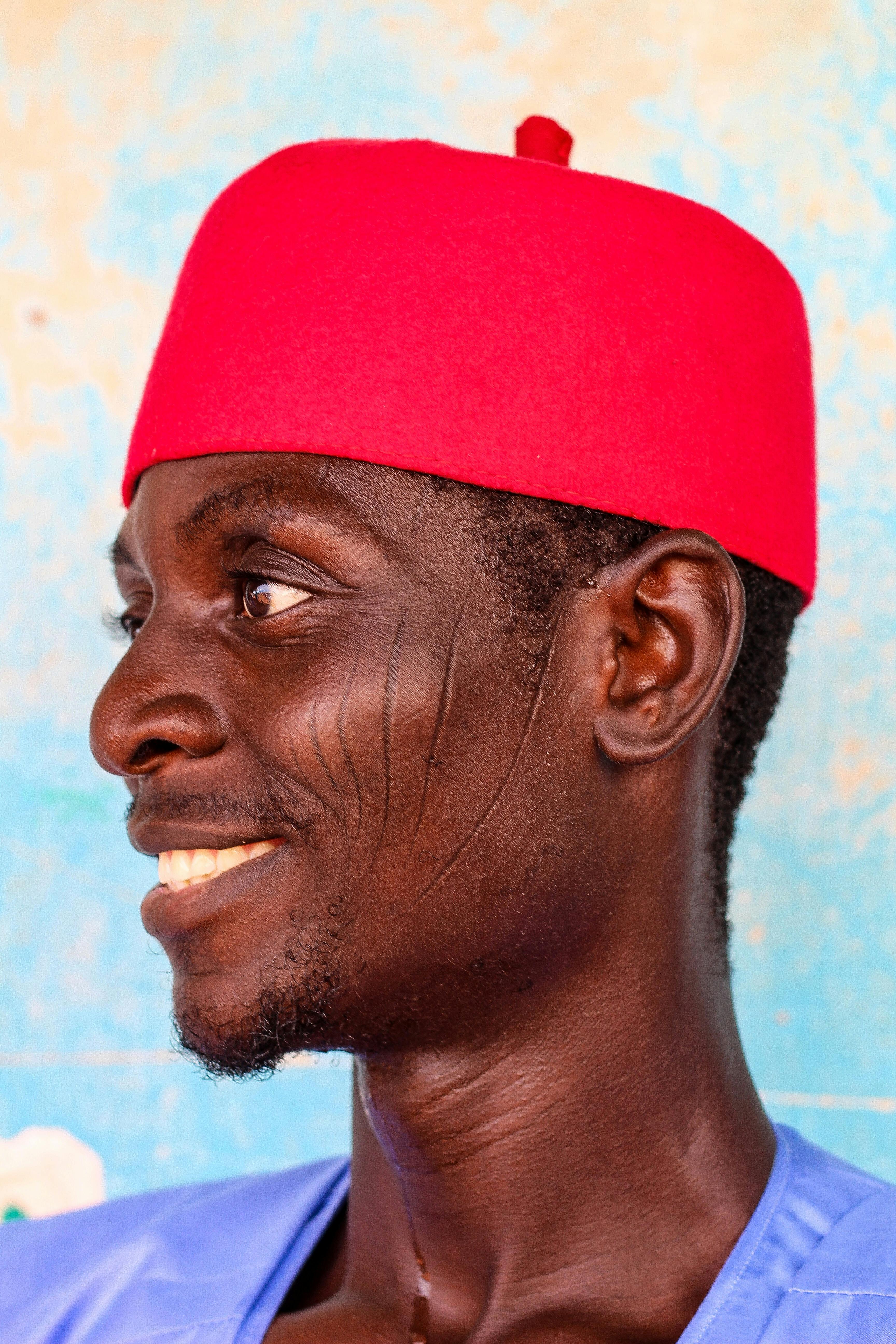 Smiling Man in Red Hat · Free Stock Photo
