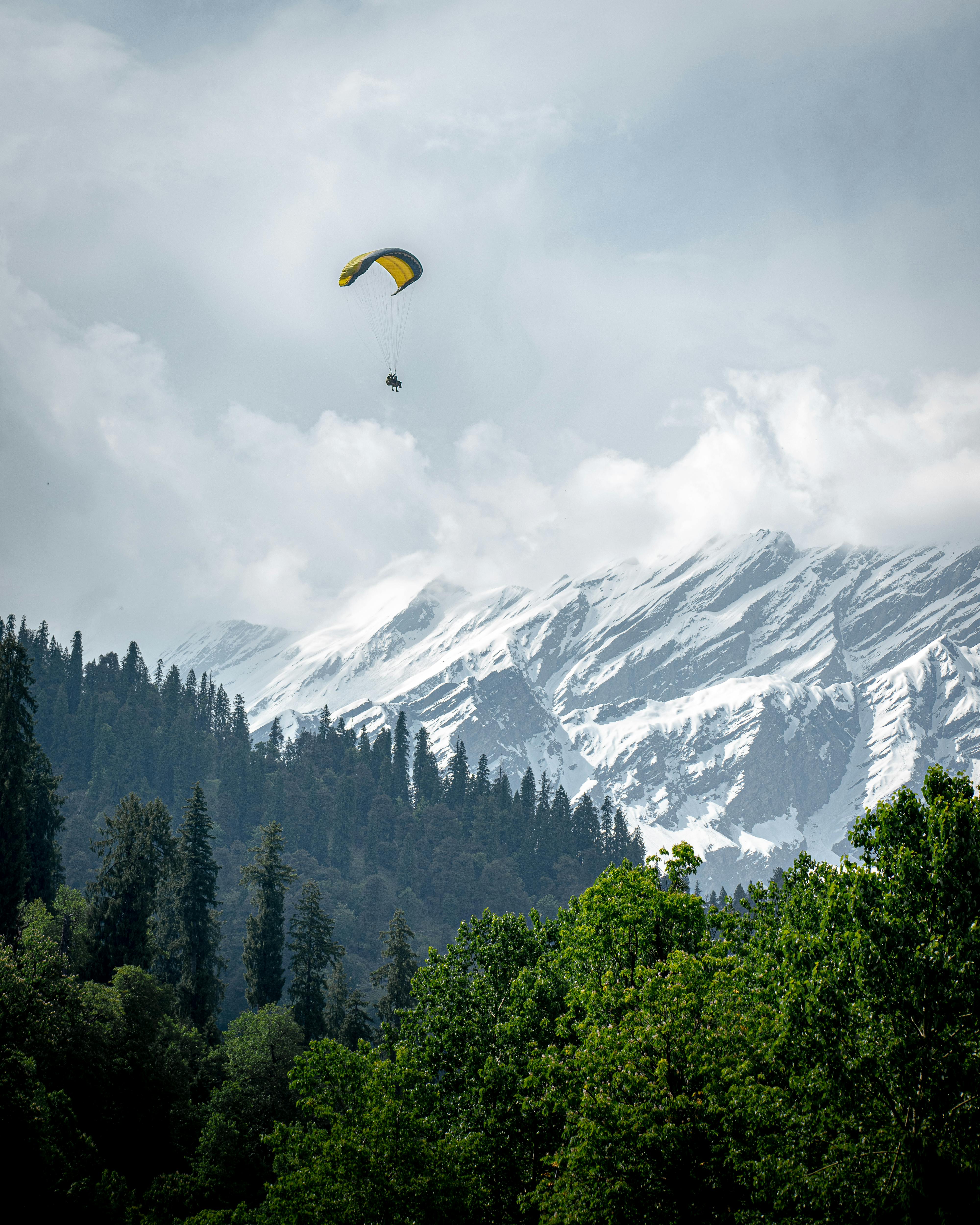 Paraglider in Air over Woods Near Himalayas · Free Stock Photo