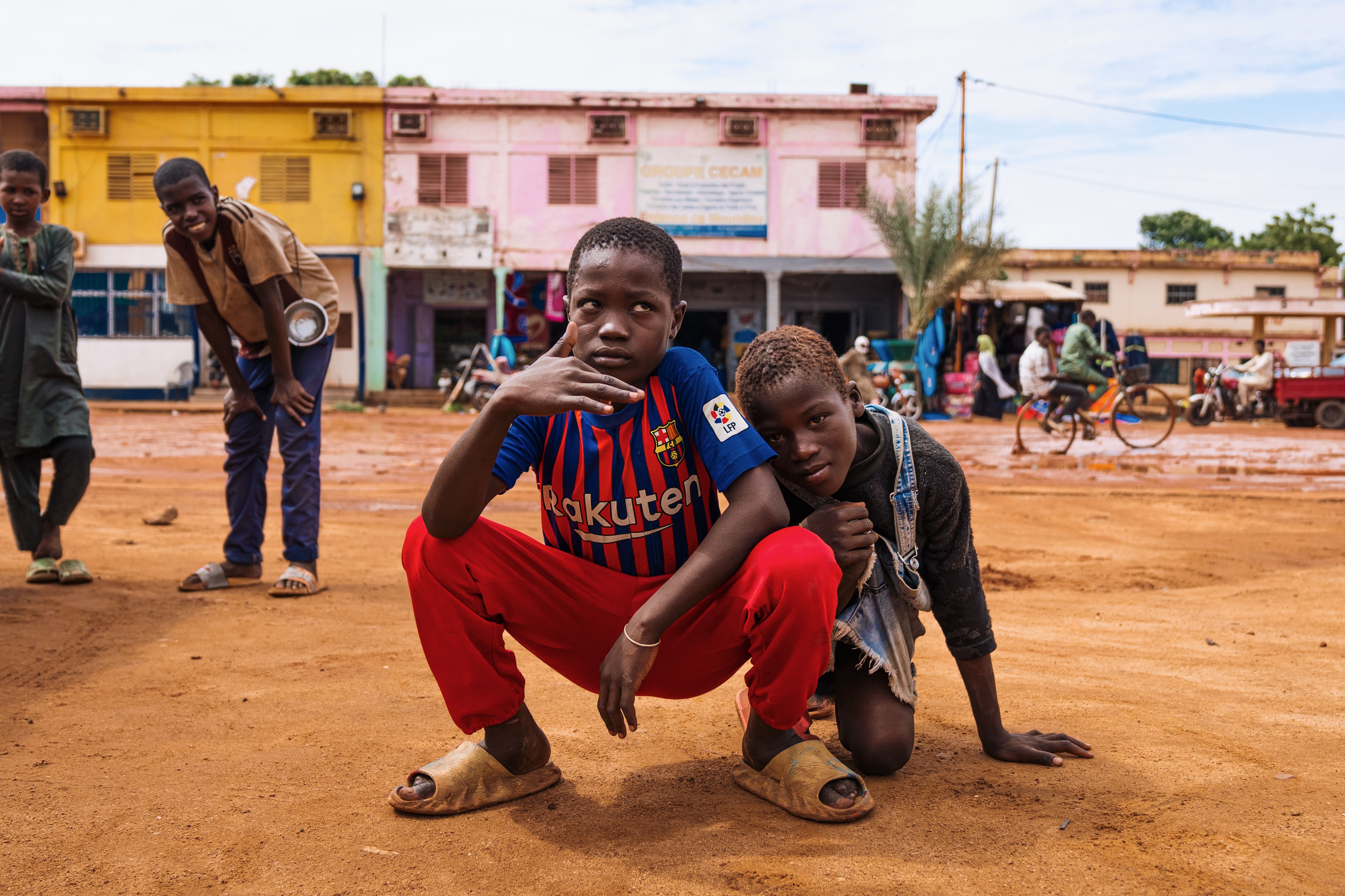 Boys Posing on Sandy Street · Free Stock Photo