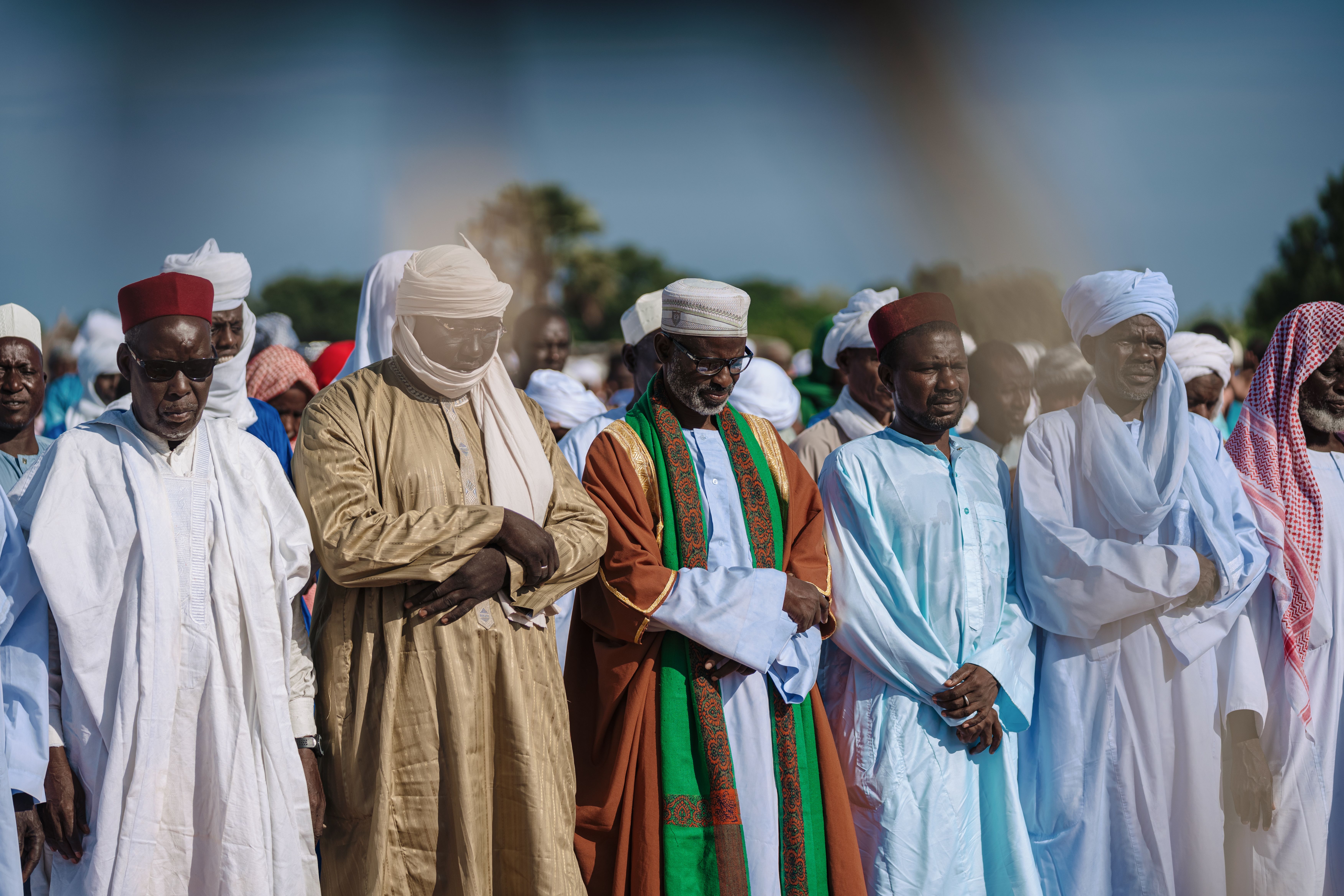 Men in Tribal Clothing Standing and Praying · Free Stock Photo