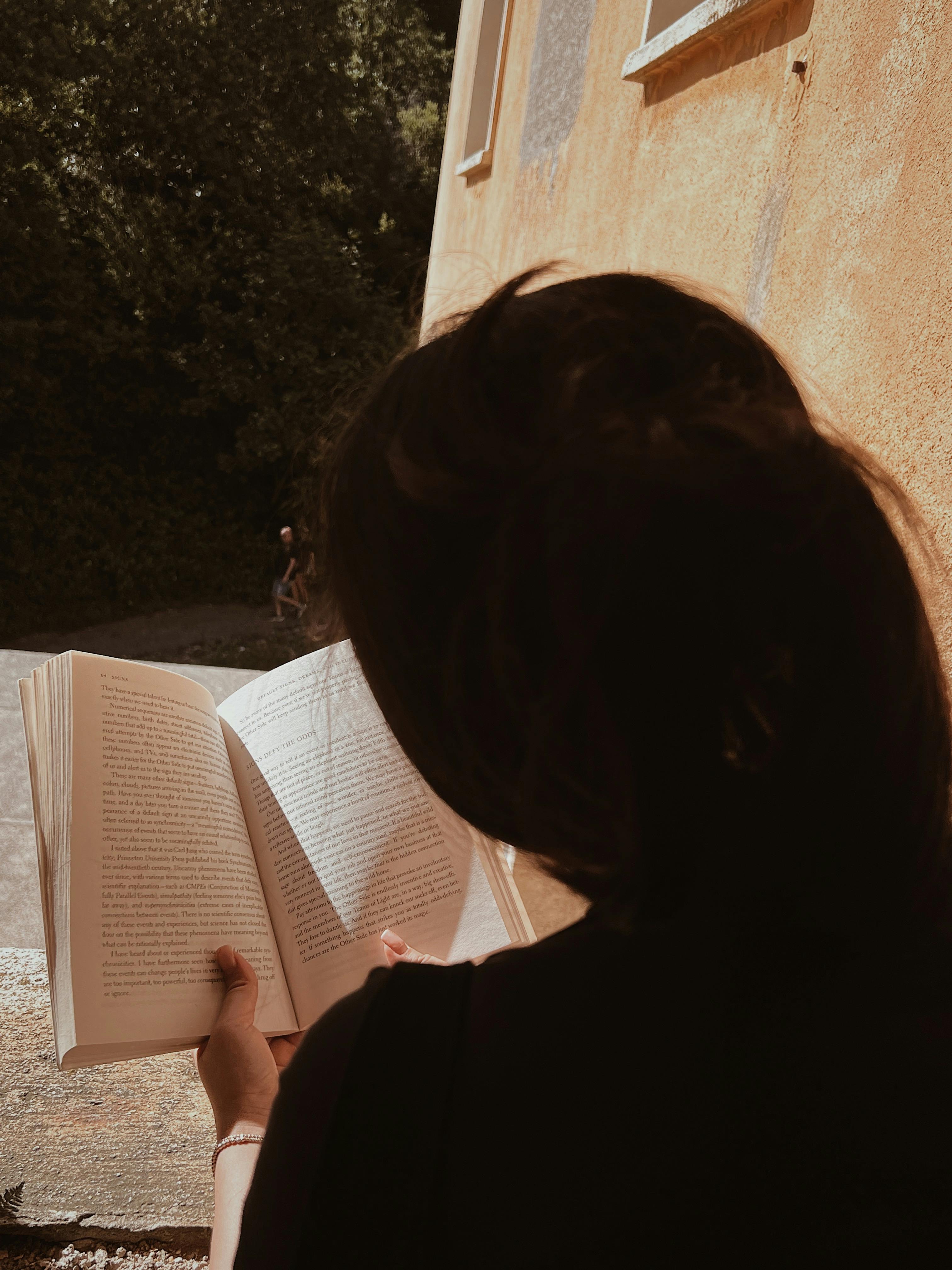 Back View of Woman Reading Book · Free Stock Photo