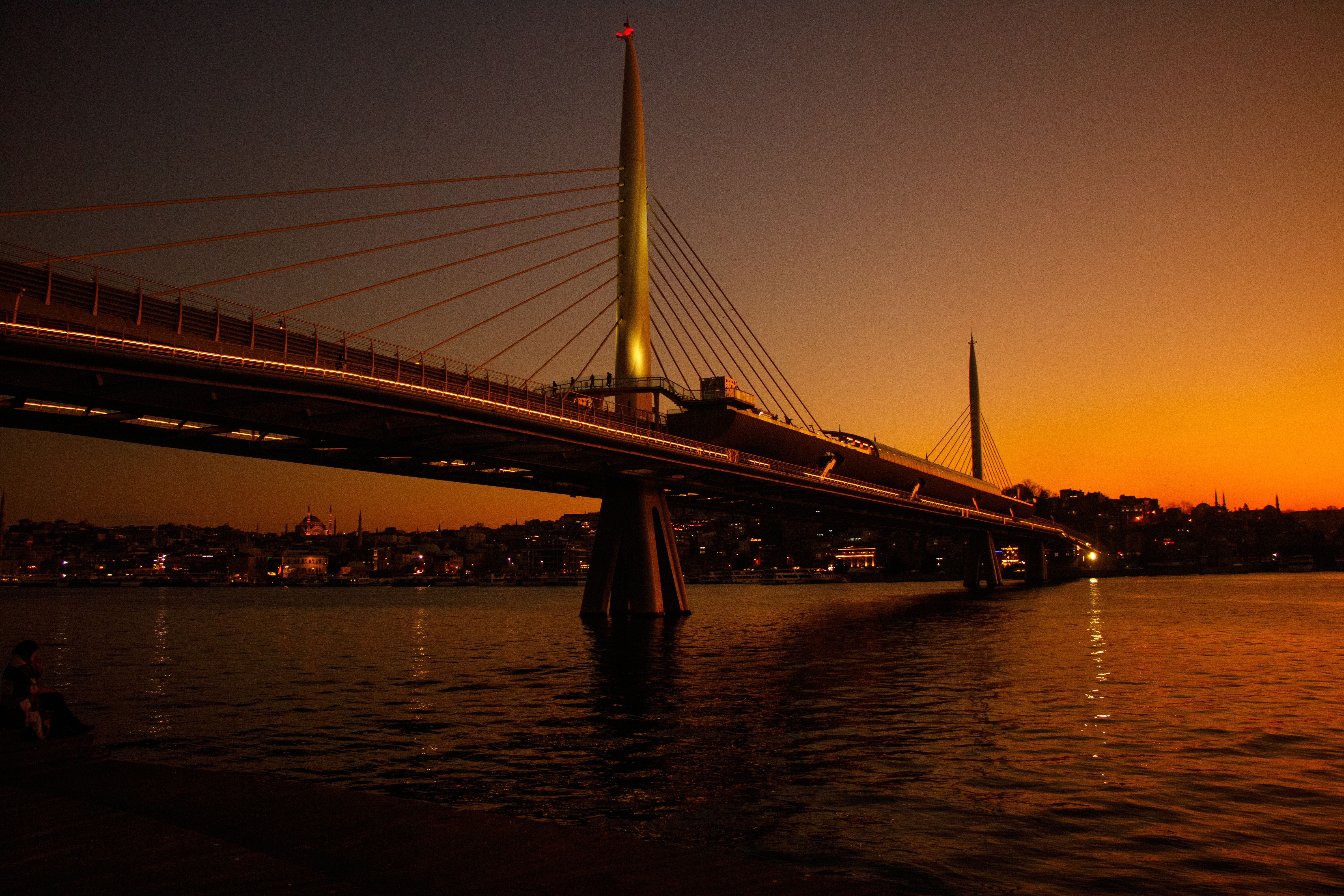 A bridge over water at sunset · Free Stock Photo