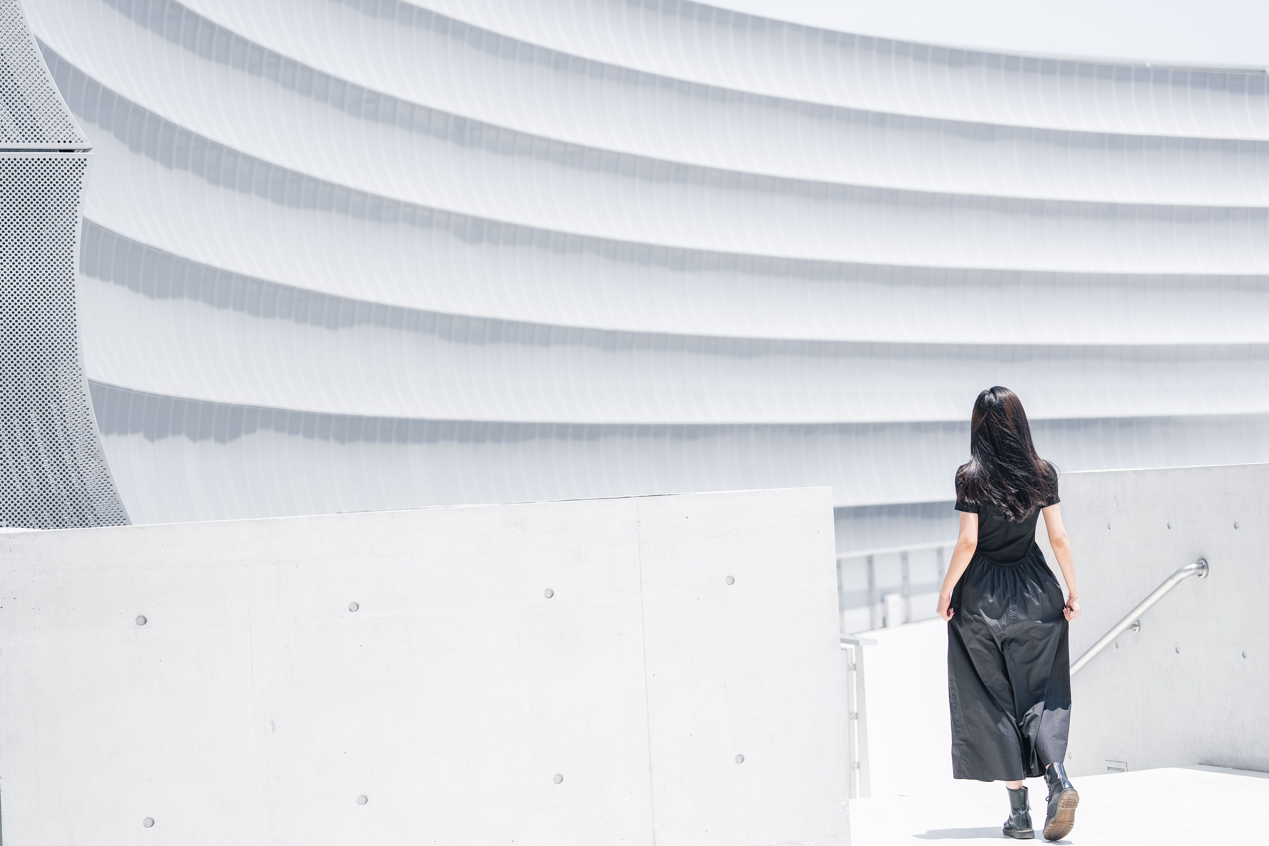 A Woman Standing by a Building · Free Stock Photo