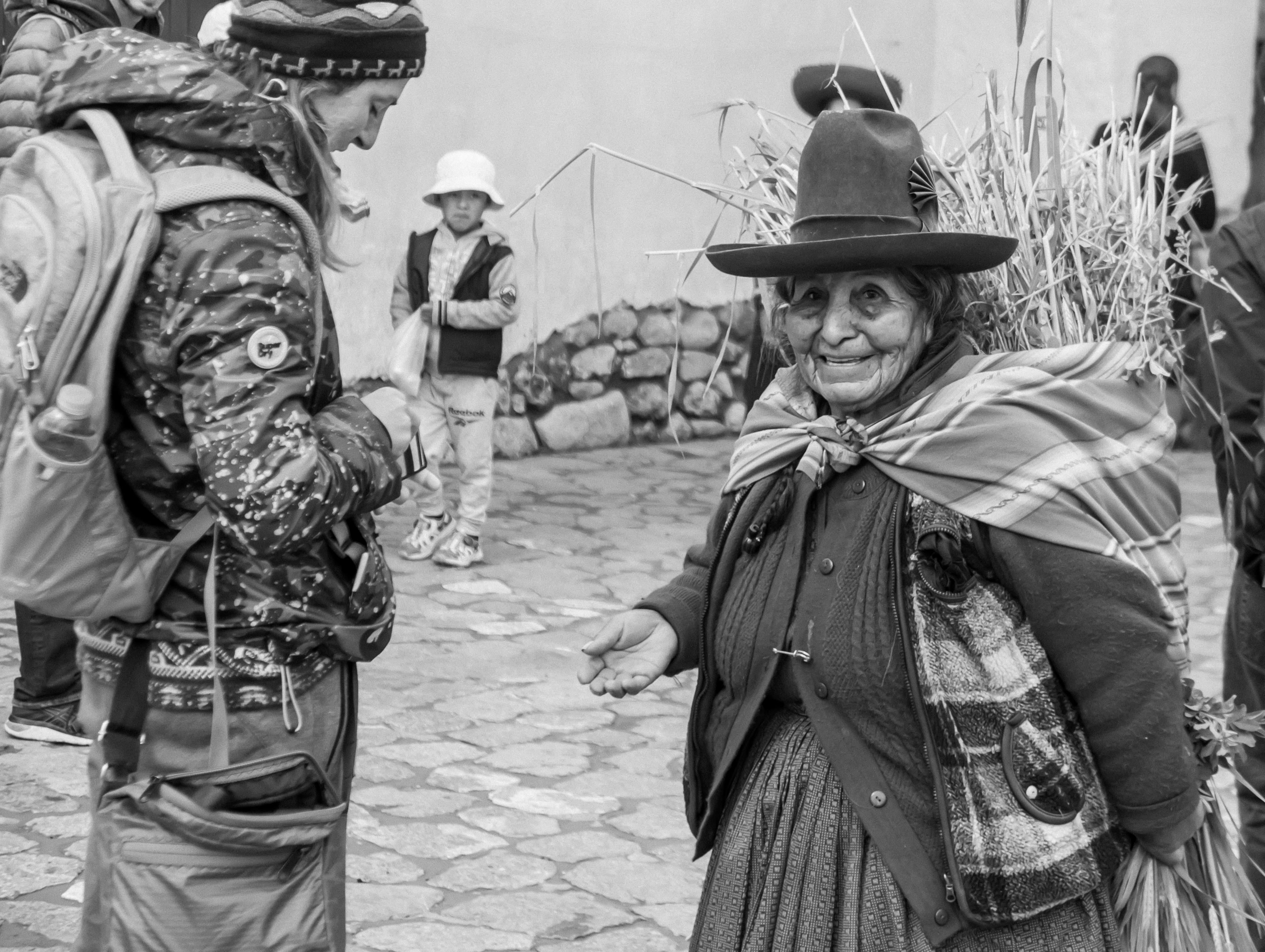 Man in Red Robe Sitting beside Green Metal Fence · Free Stock Photo