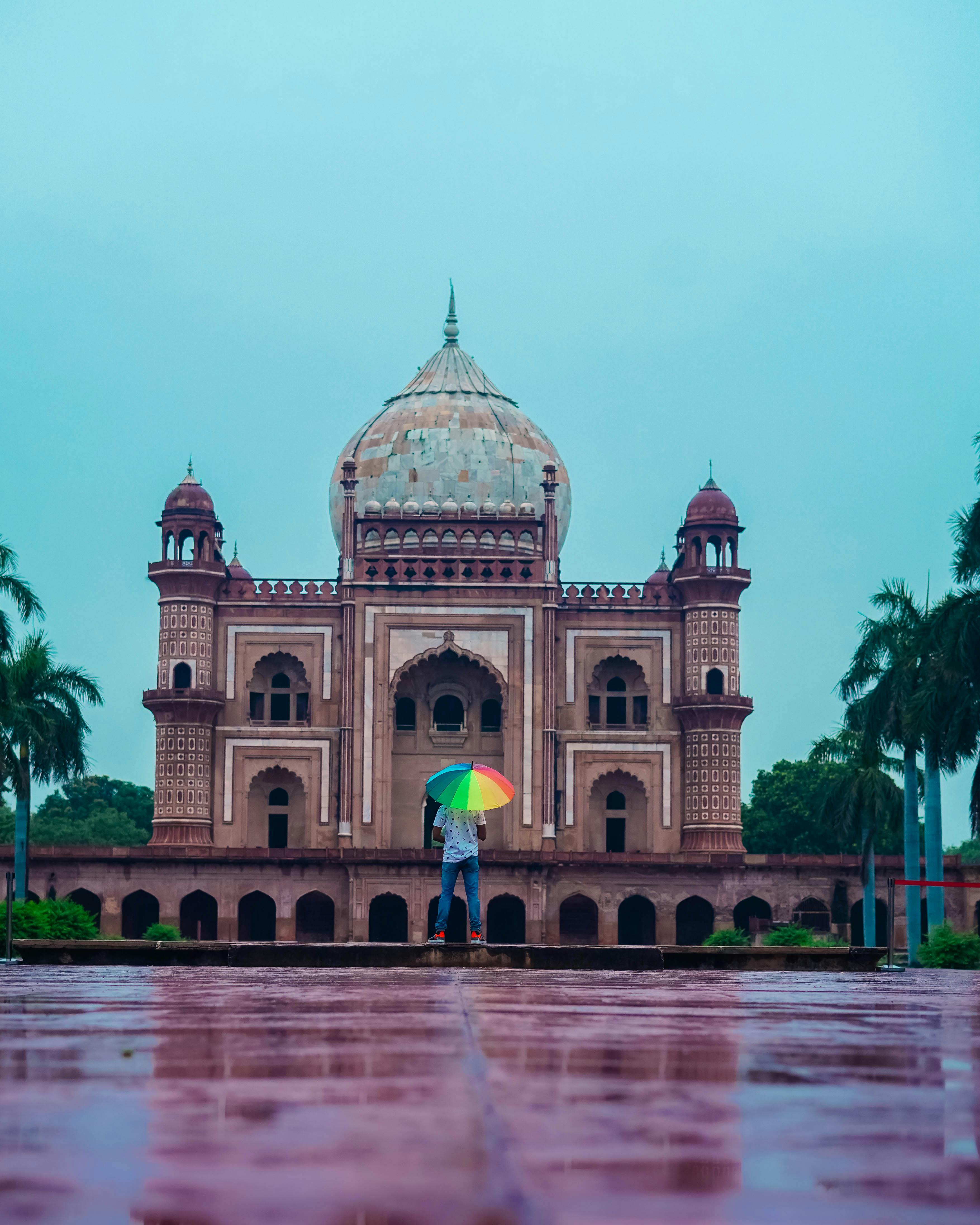 A Person with a Rainbow Umbrella Standing in front of the Tomb of ...