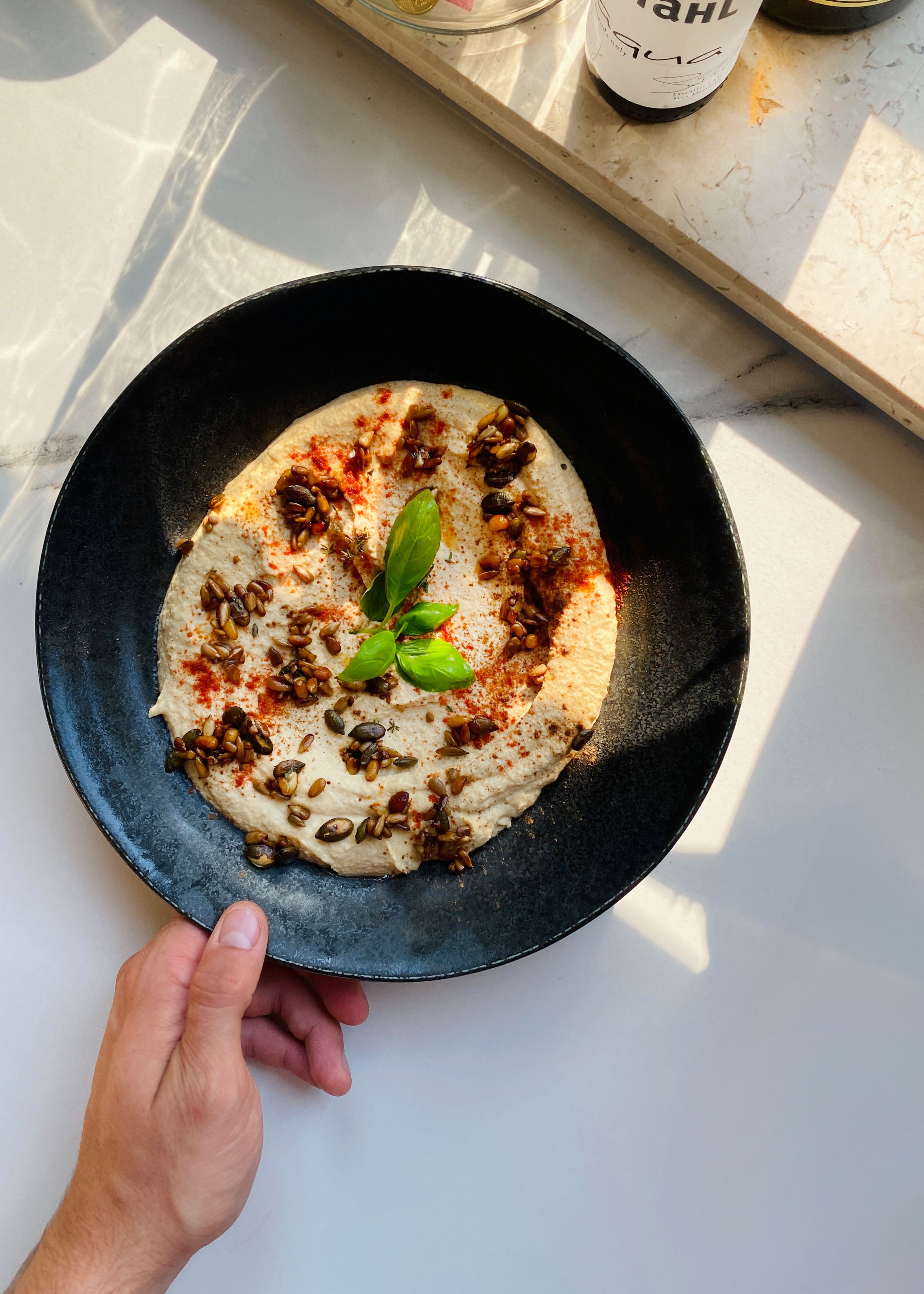 A Person Holding a Plate with Hummus · Free Stock Photo