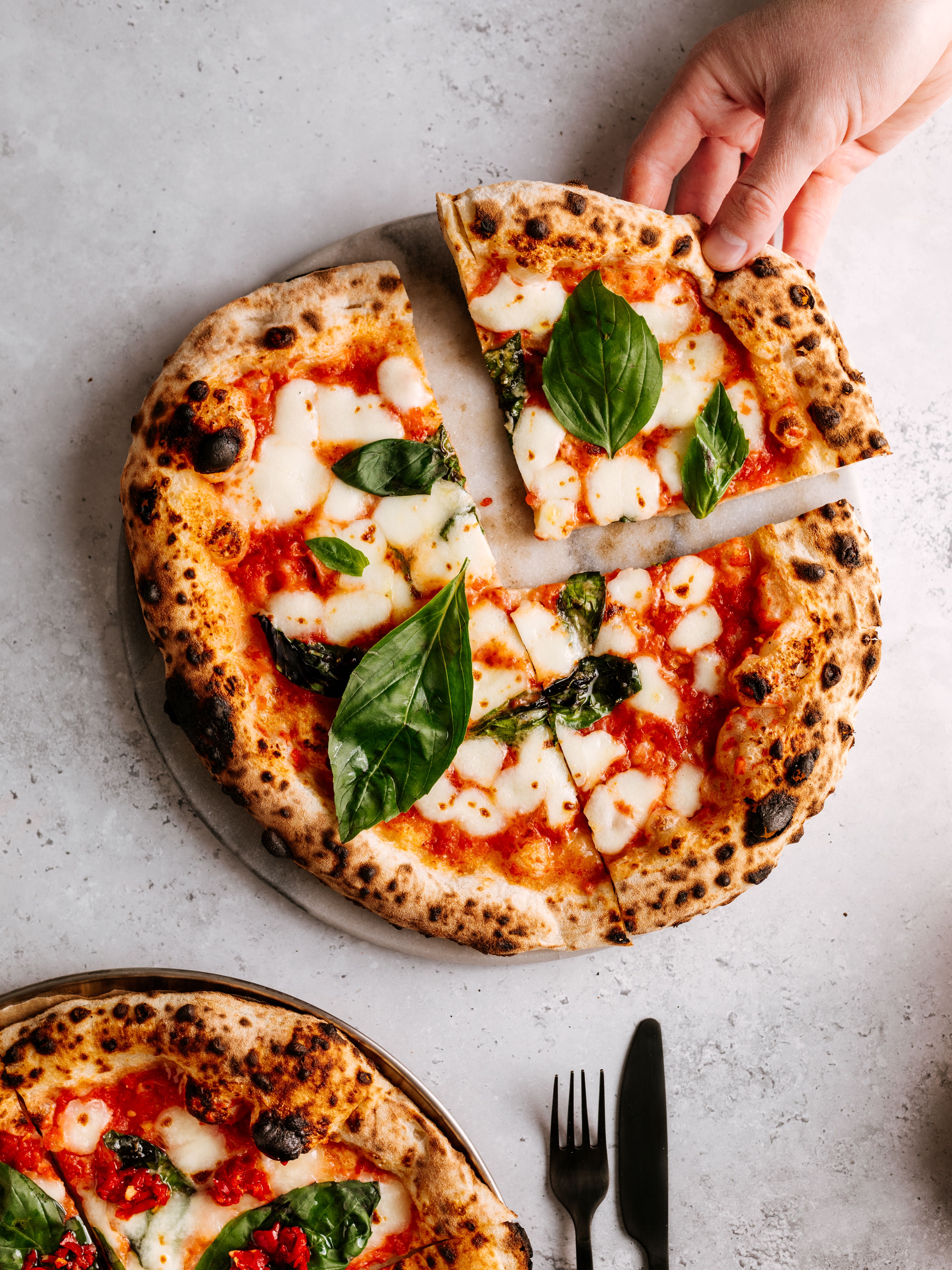 Hand Holding Pizza · Free Stock Photo