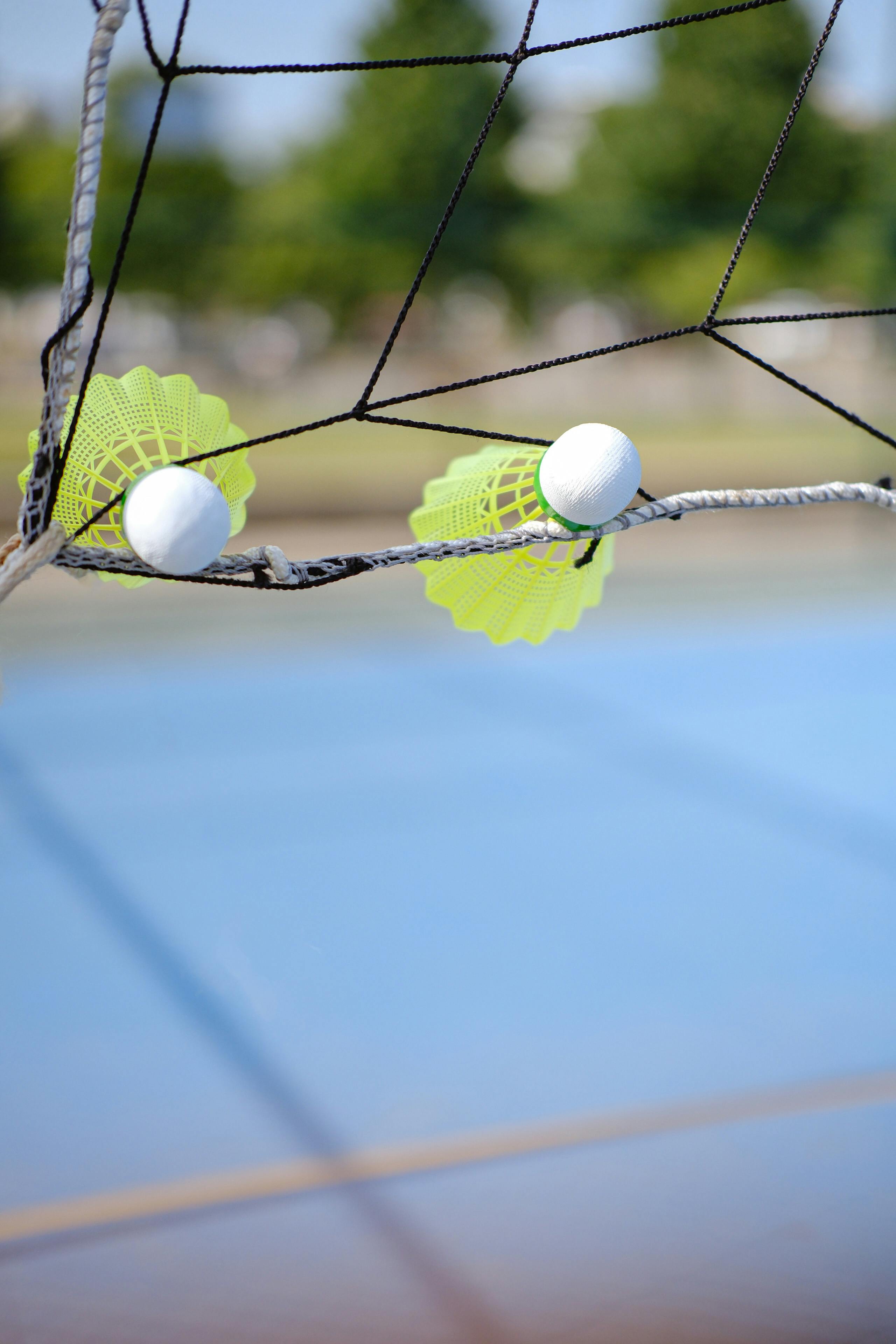 Yellow Badminton Shuttlecocks Sticking in a Net · Free Stock Photo