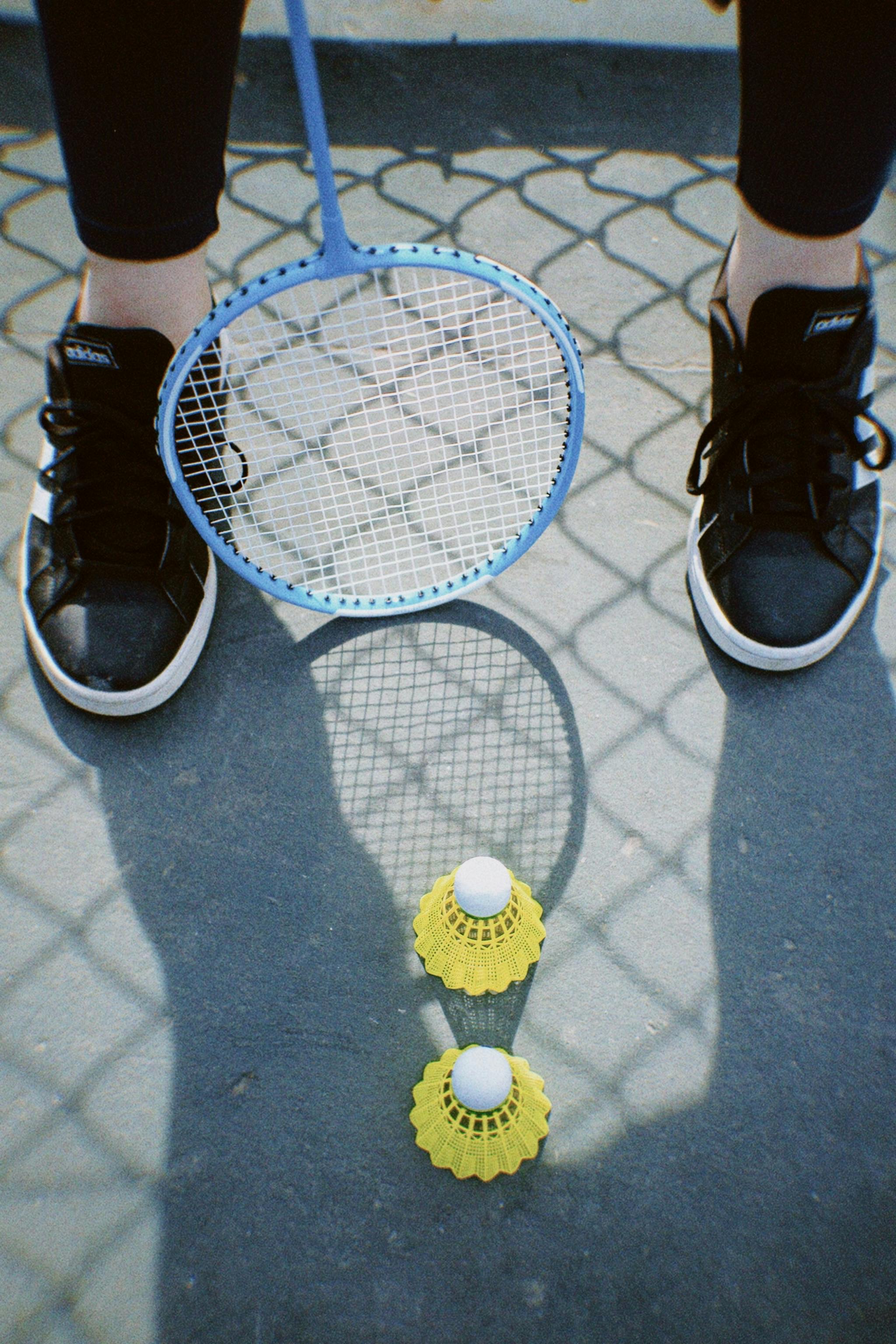 Badminton Racket and Shuttlecocks on the Court · Free Stock Photo