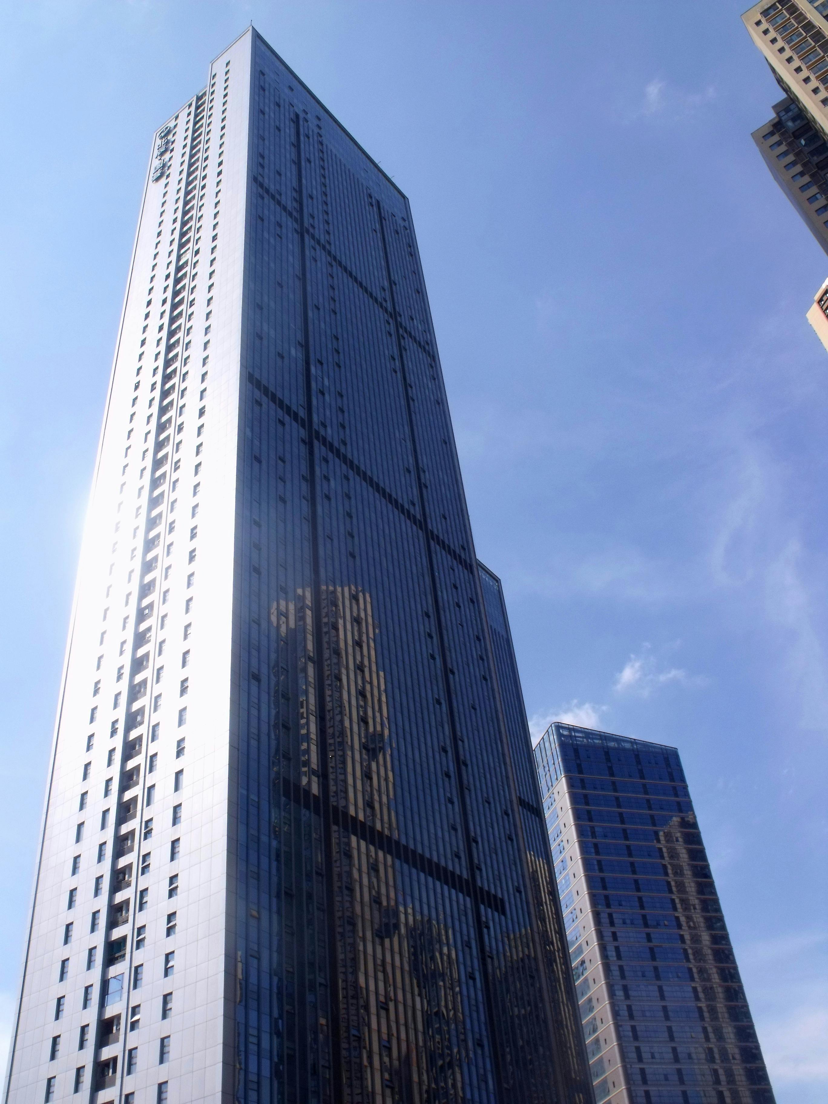 Low Angle Shot of a Modern Skyscraper under Blue Sky · Free Stock Photo