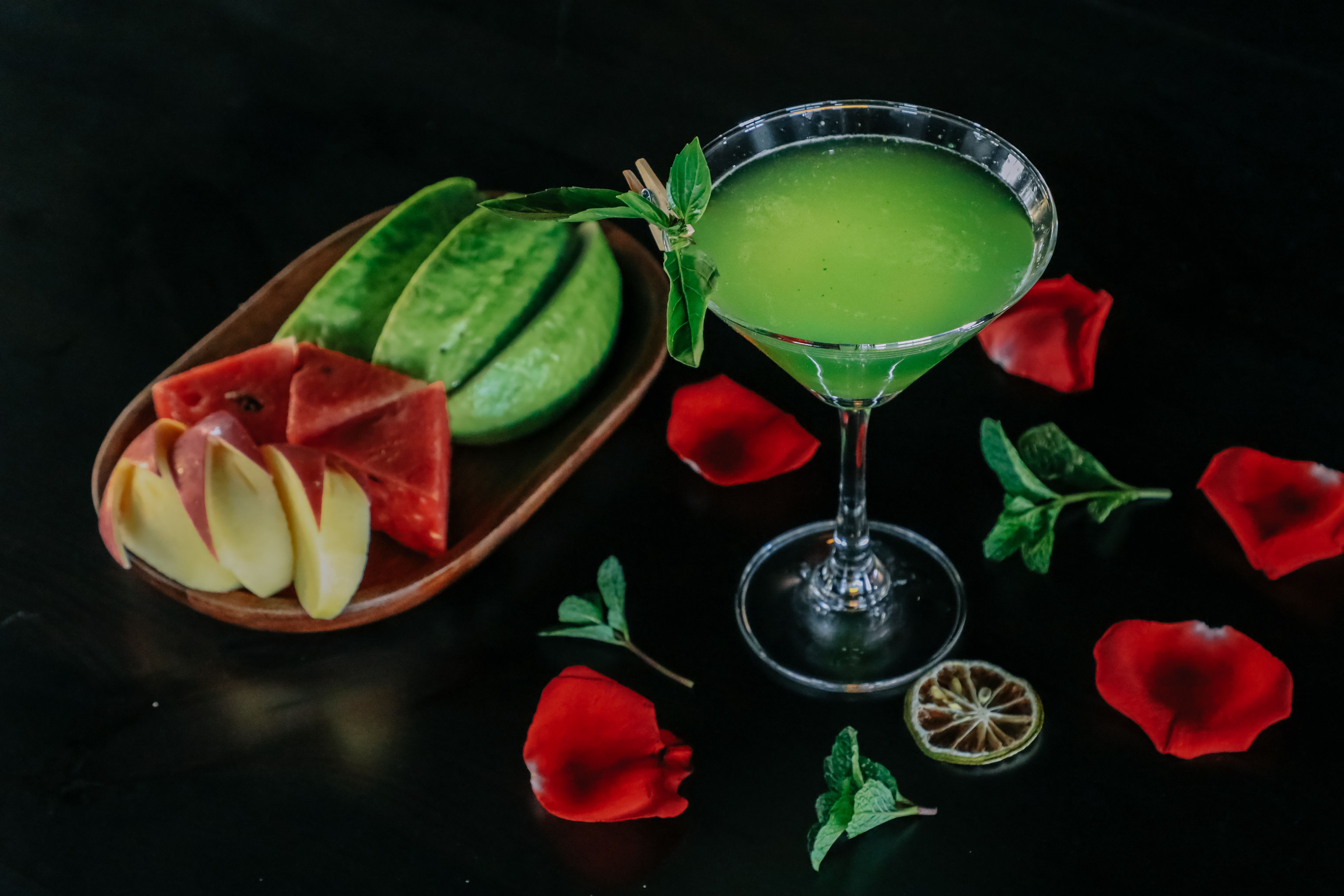 Green Drink in a Martini Glass and Fruits on a Tray Standing against a ...