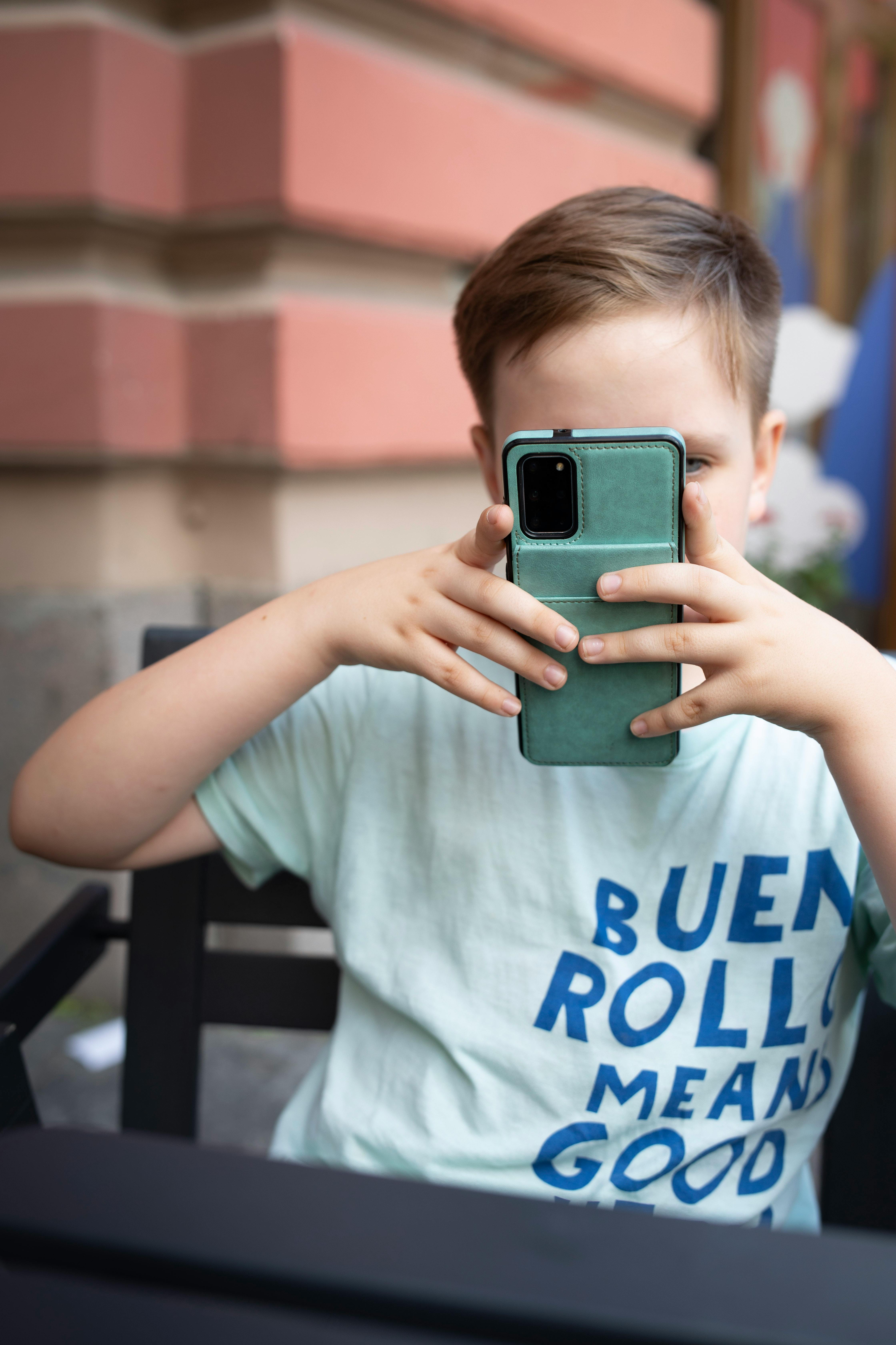 Boy Taking Photo with Smartphone · Free Stock Photo