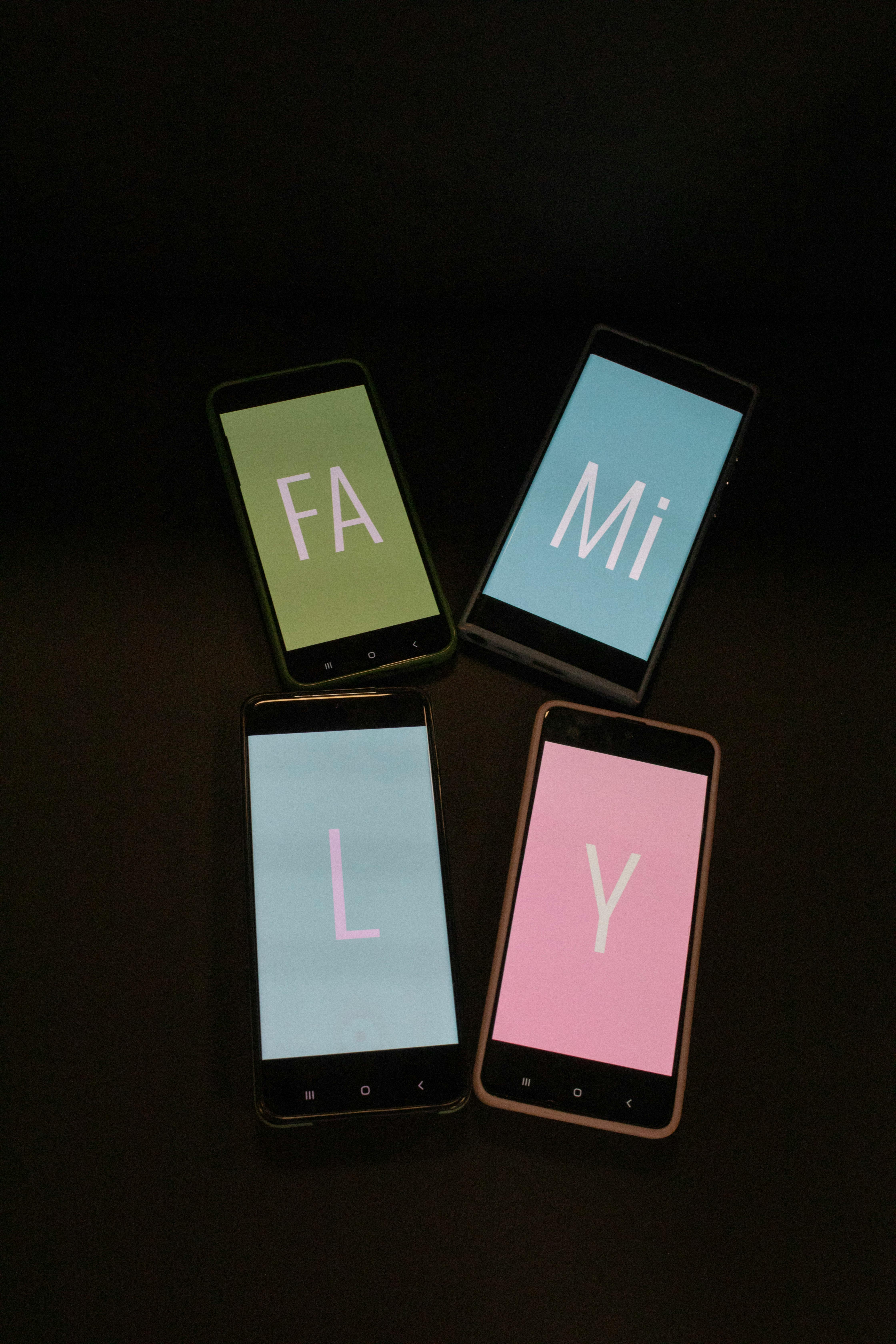 Smartphones with Wallpapers Saying Family · Free Stock Photo