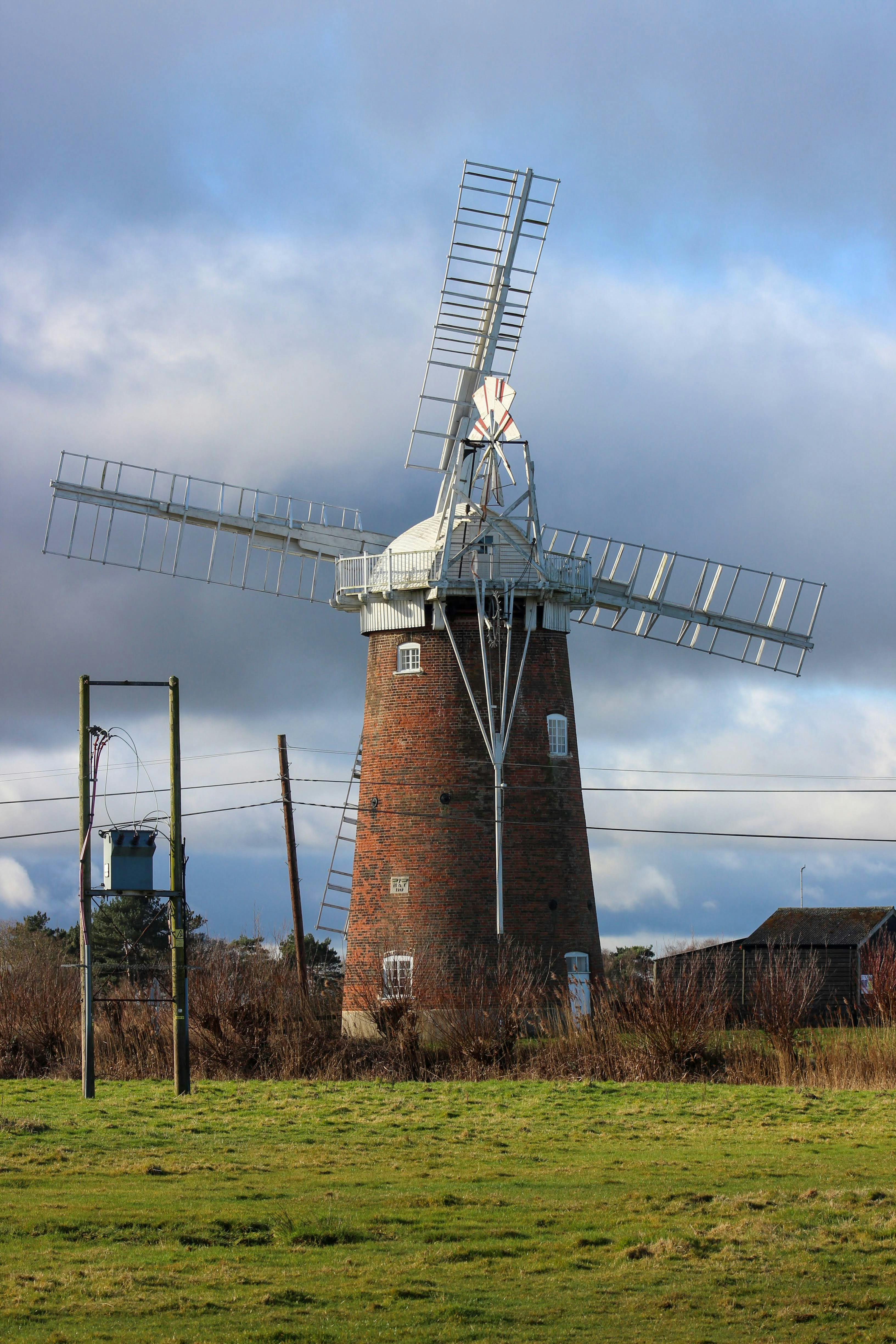 Brown and Gray Windmill Beside Green Tree Under Blue Cloudy Sky during ...