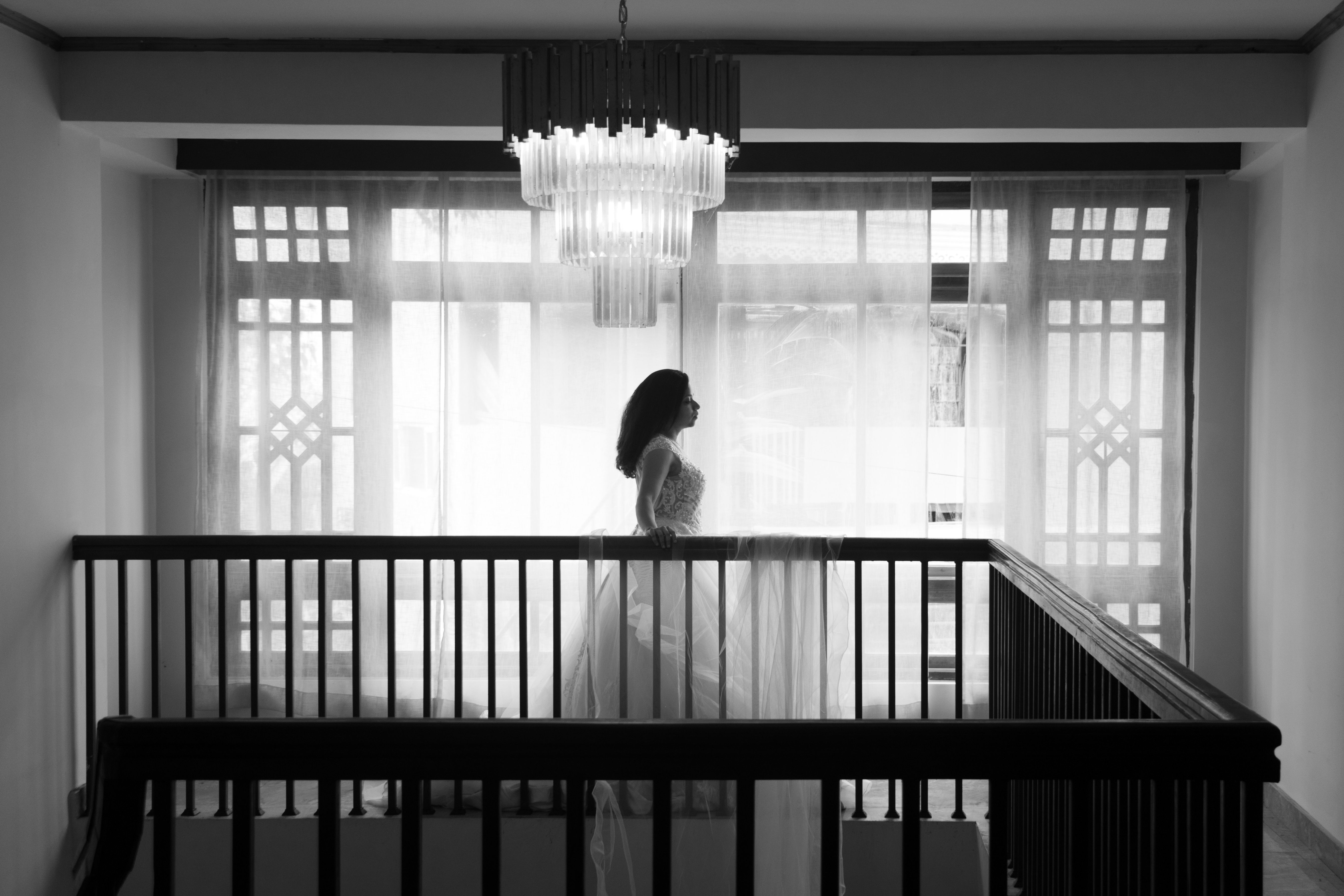 Black and White Picture of a Bride Standing by the Windows in a ...