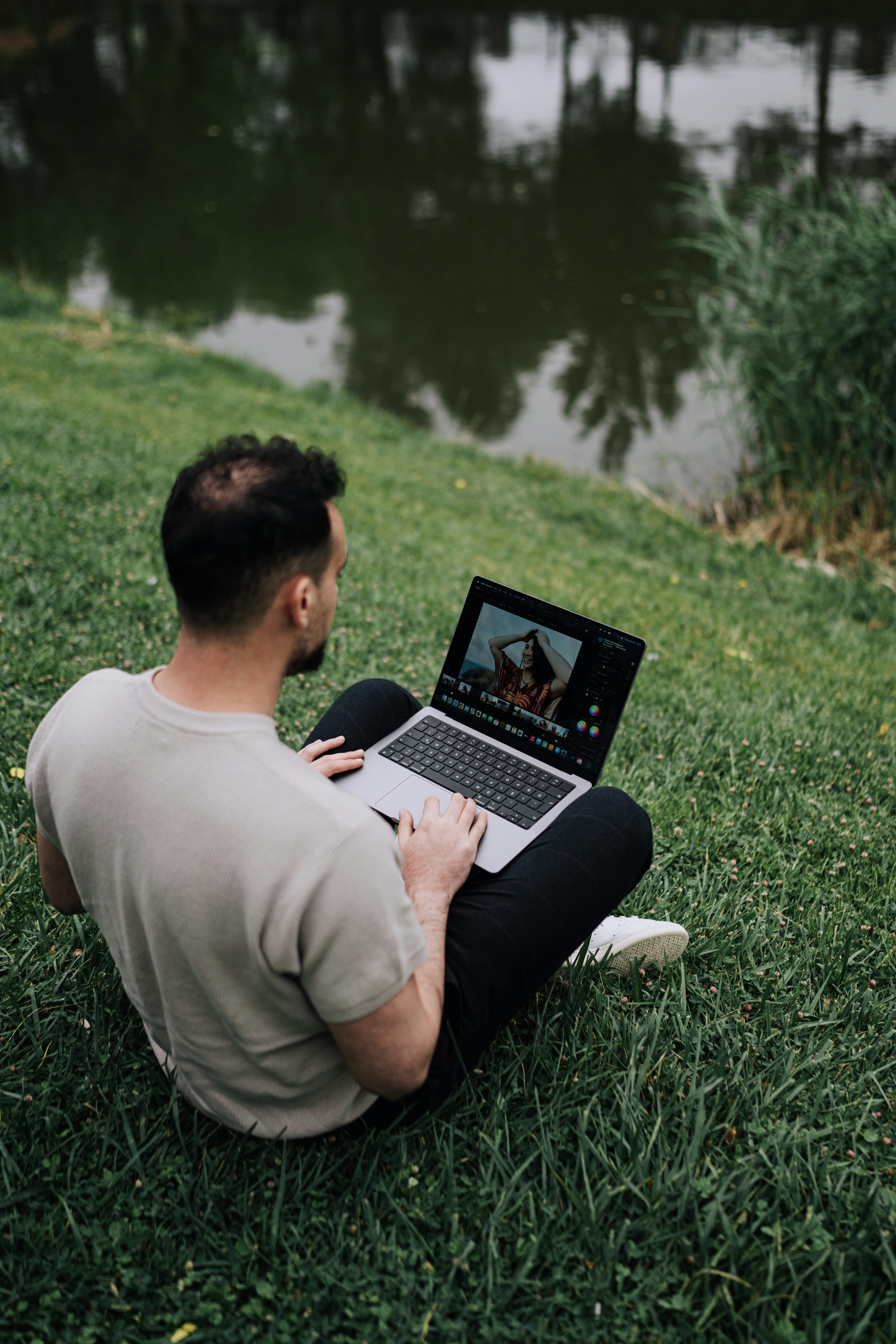 Man Looking at his Gray Laptop · Free Stock Photo