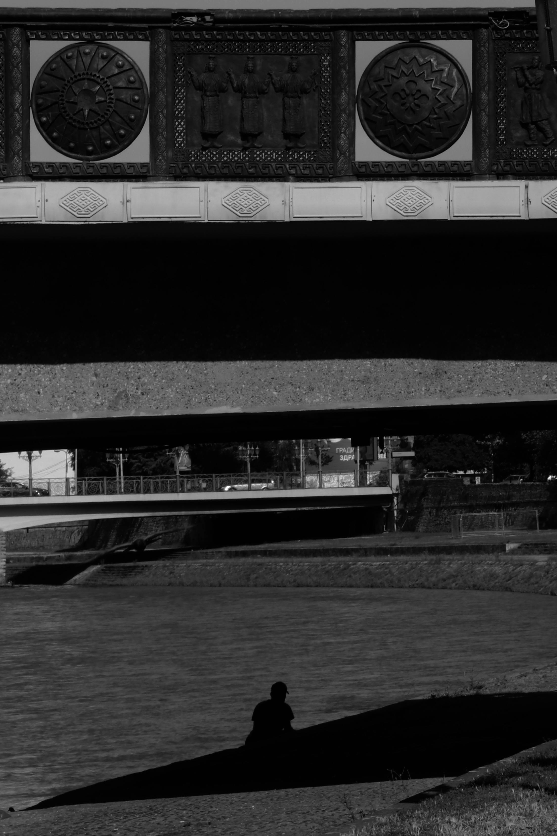 Man Hiding in the Shadow of a Ornate Bridge · Free Stock Photo