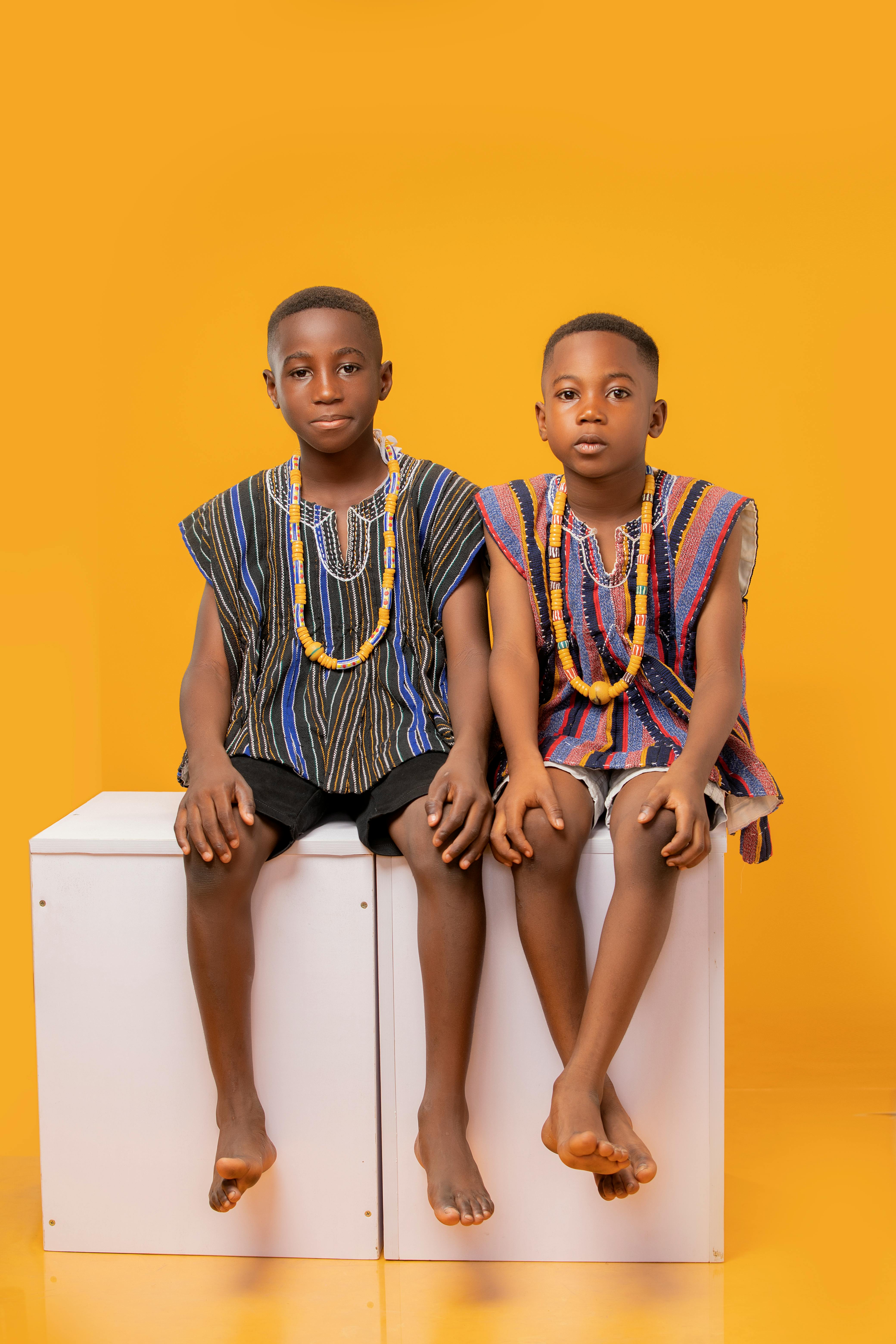 Kids in Traditional Clothes Posing on Yellow Background · Free Stock Photo