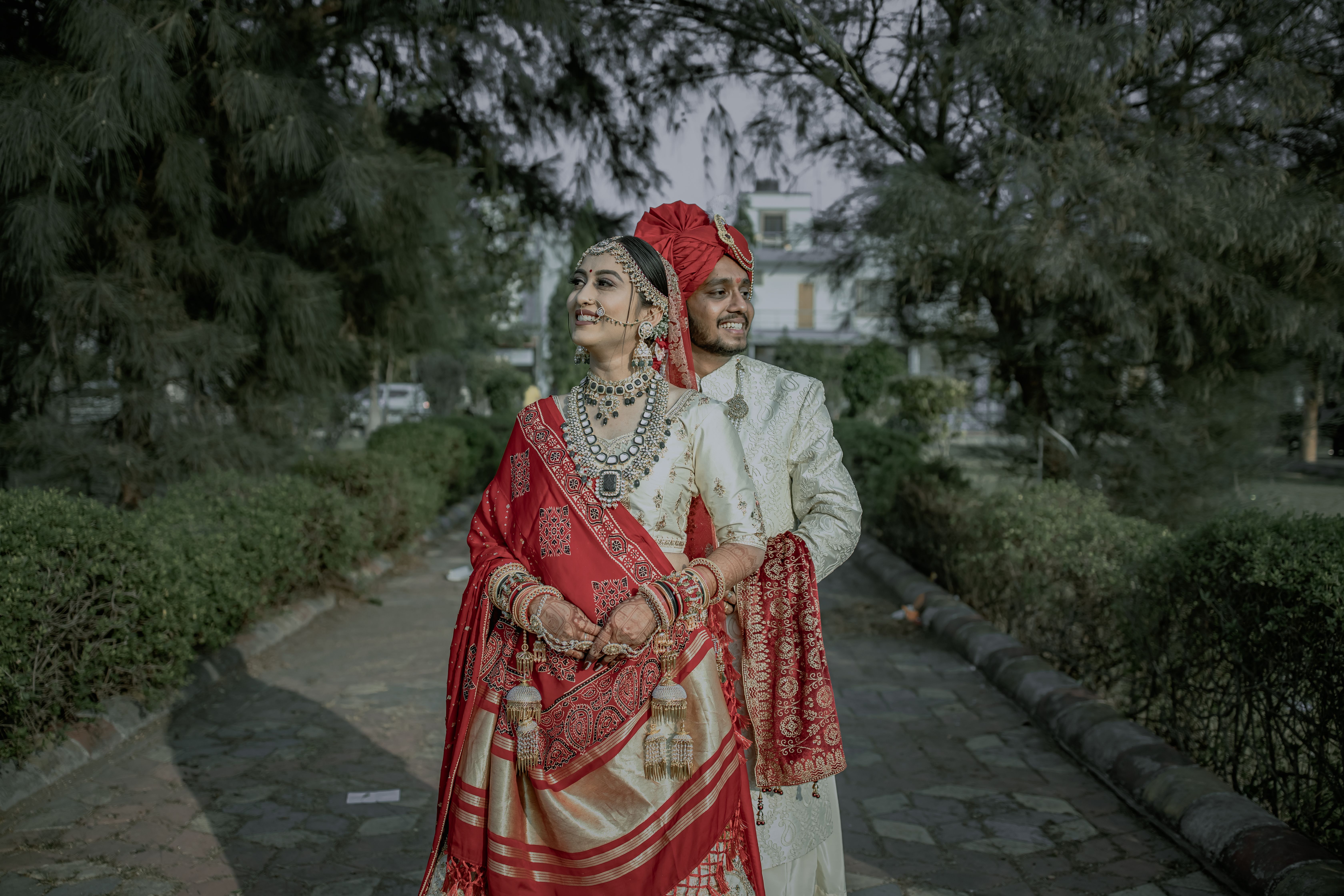 A couple in traditional indian attire pose for a photo · Free Stock Photo
