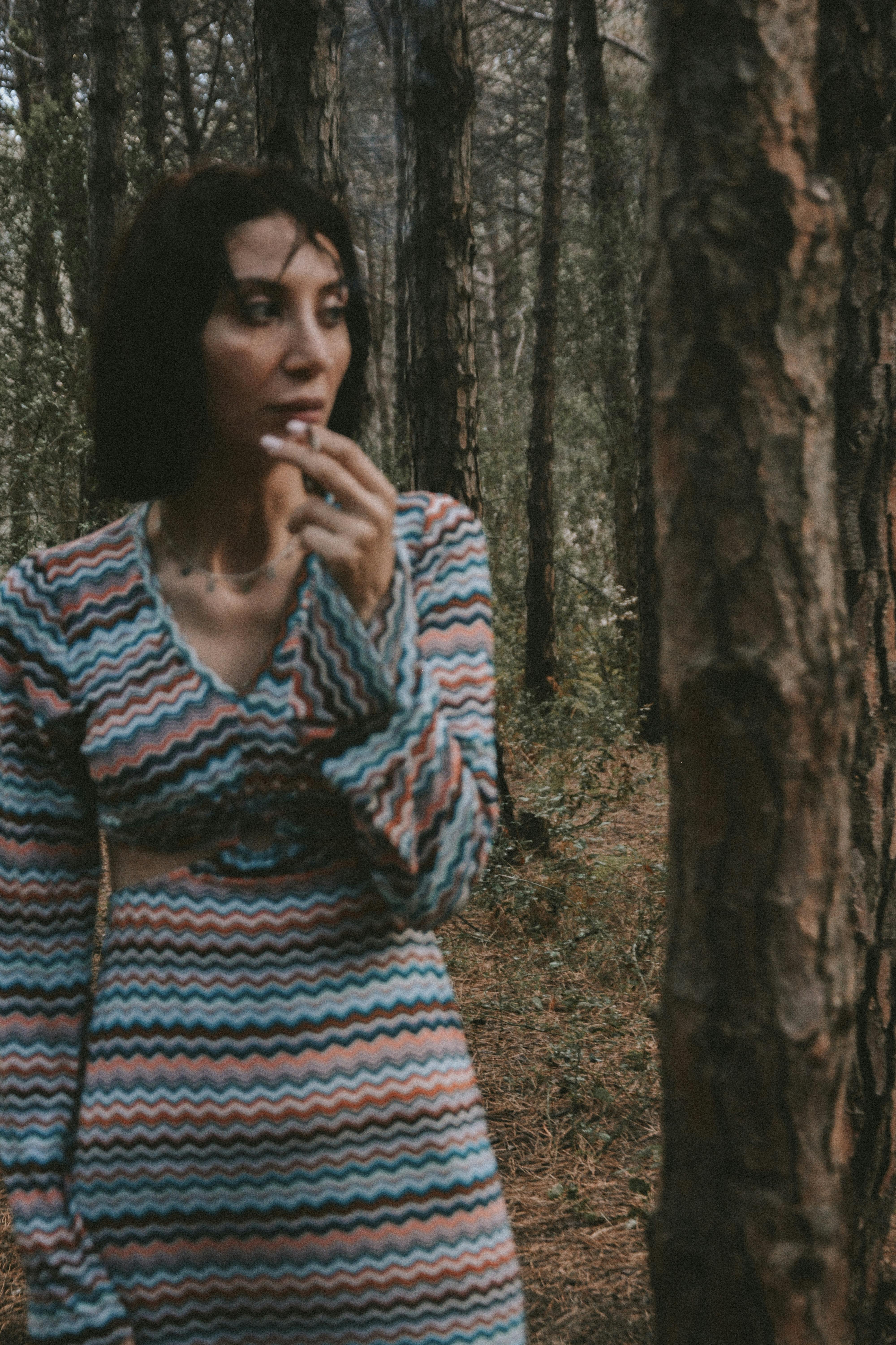 Woman Smoking a Cigarette in a Forest · Free Stock Photo