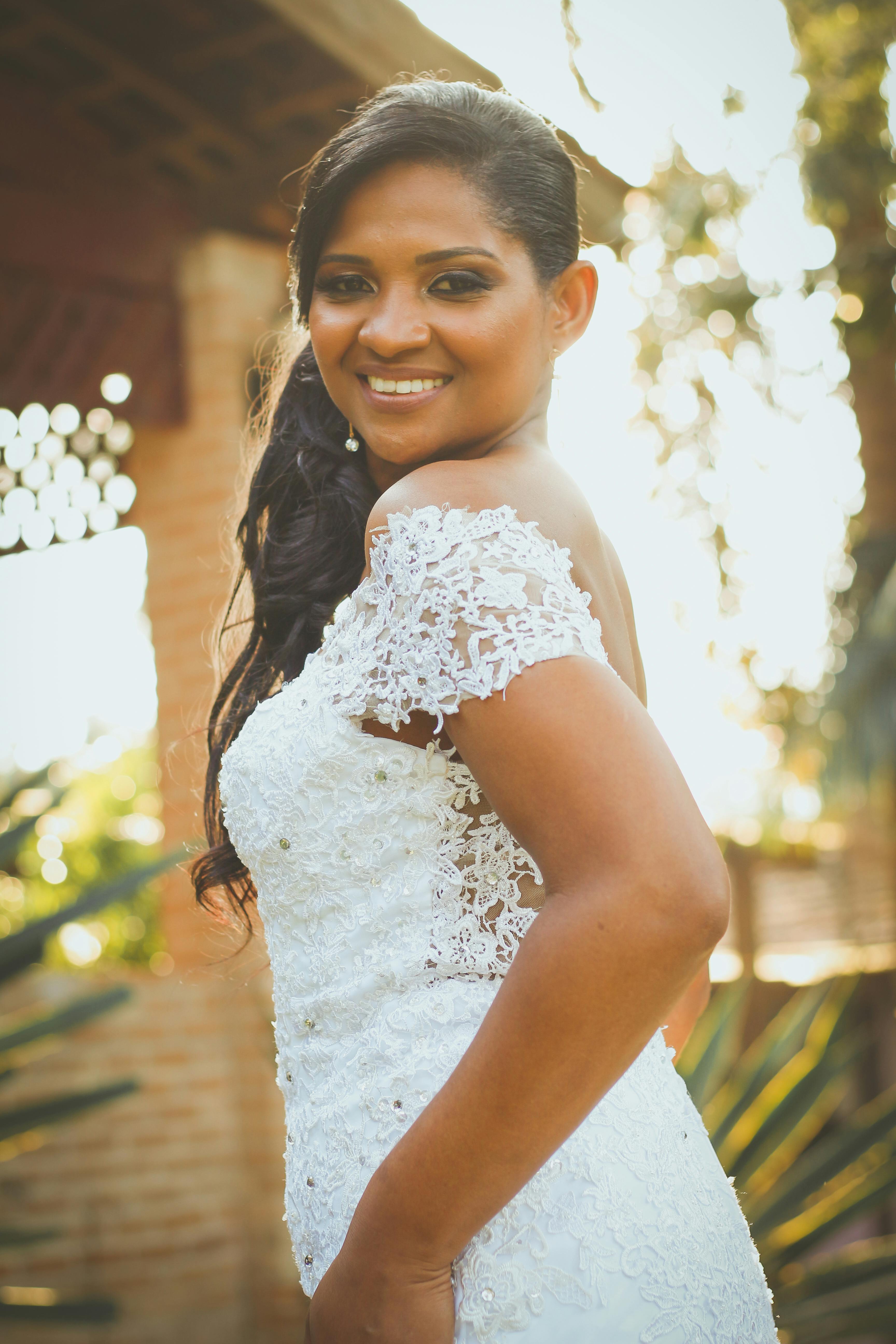 Woman Standing in Front of White Wall · Free Stock Photo