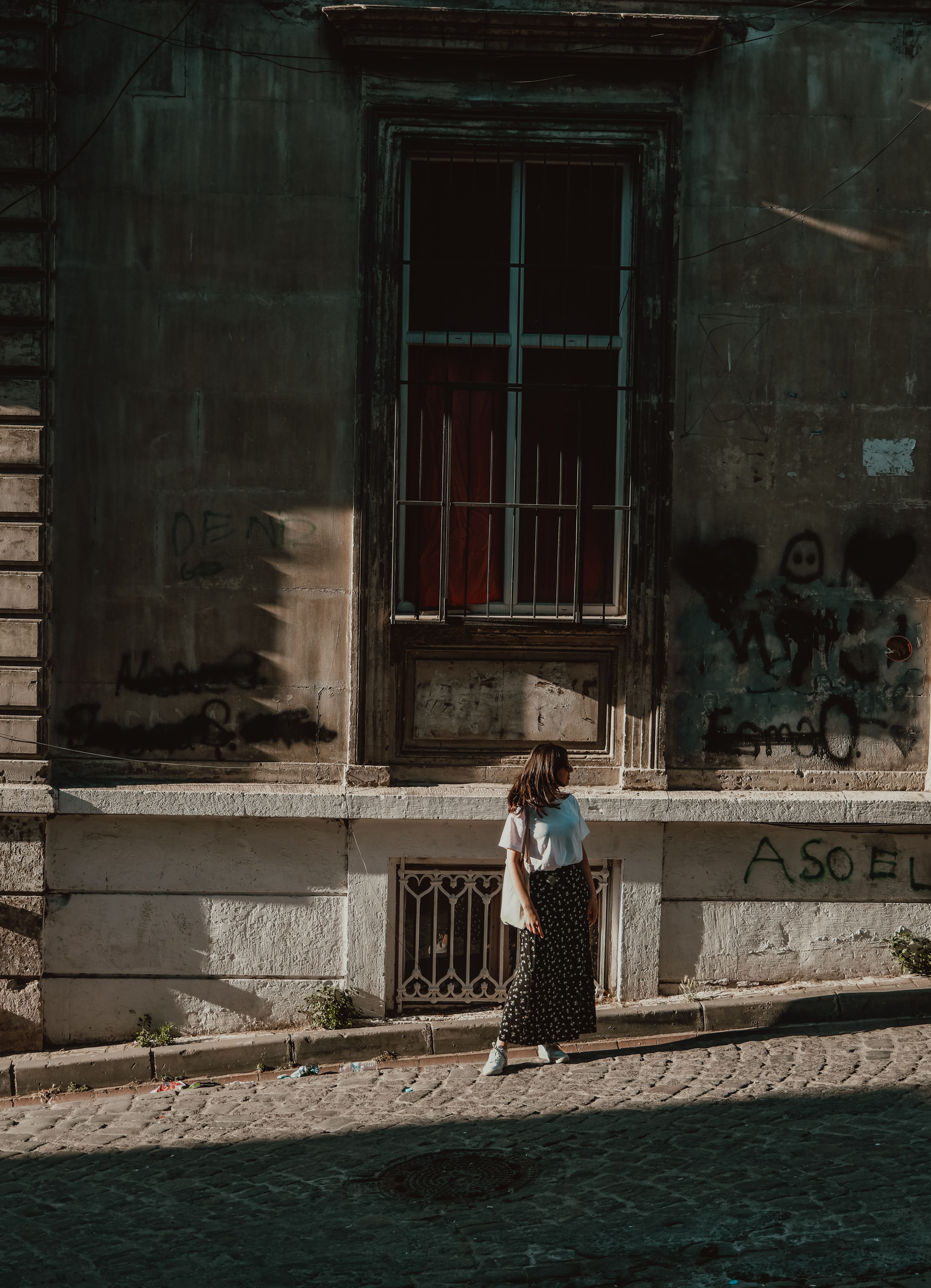 Woman Standing in Front of an Old Tenement · Free Stock Photo