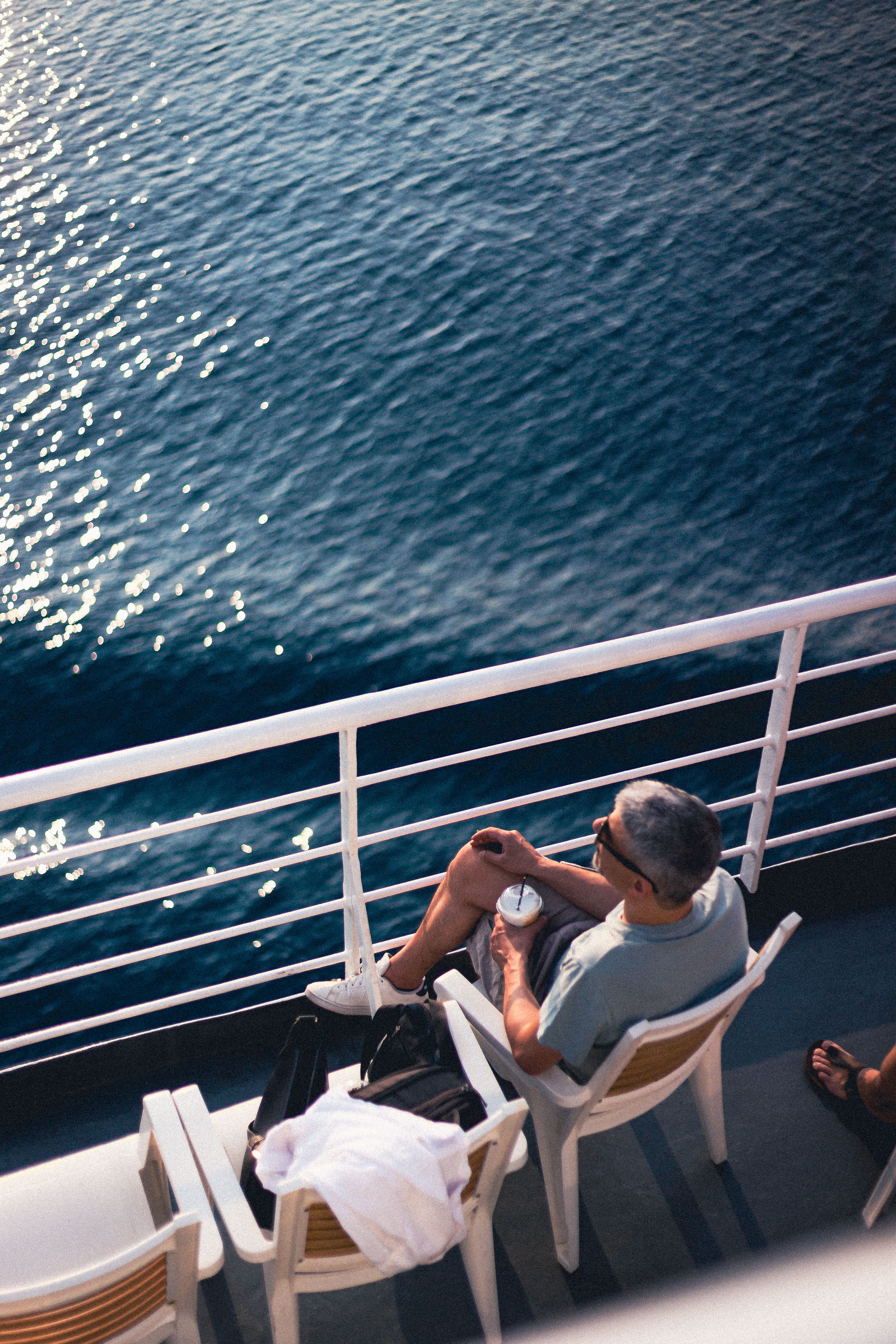 Man Sitting on a Deck · Free Stock Photo