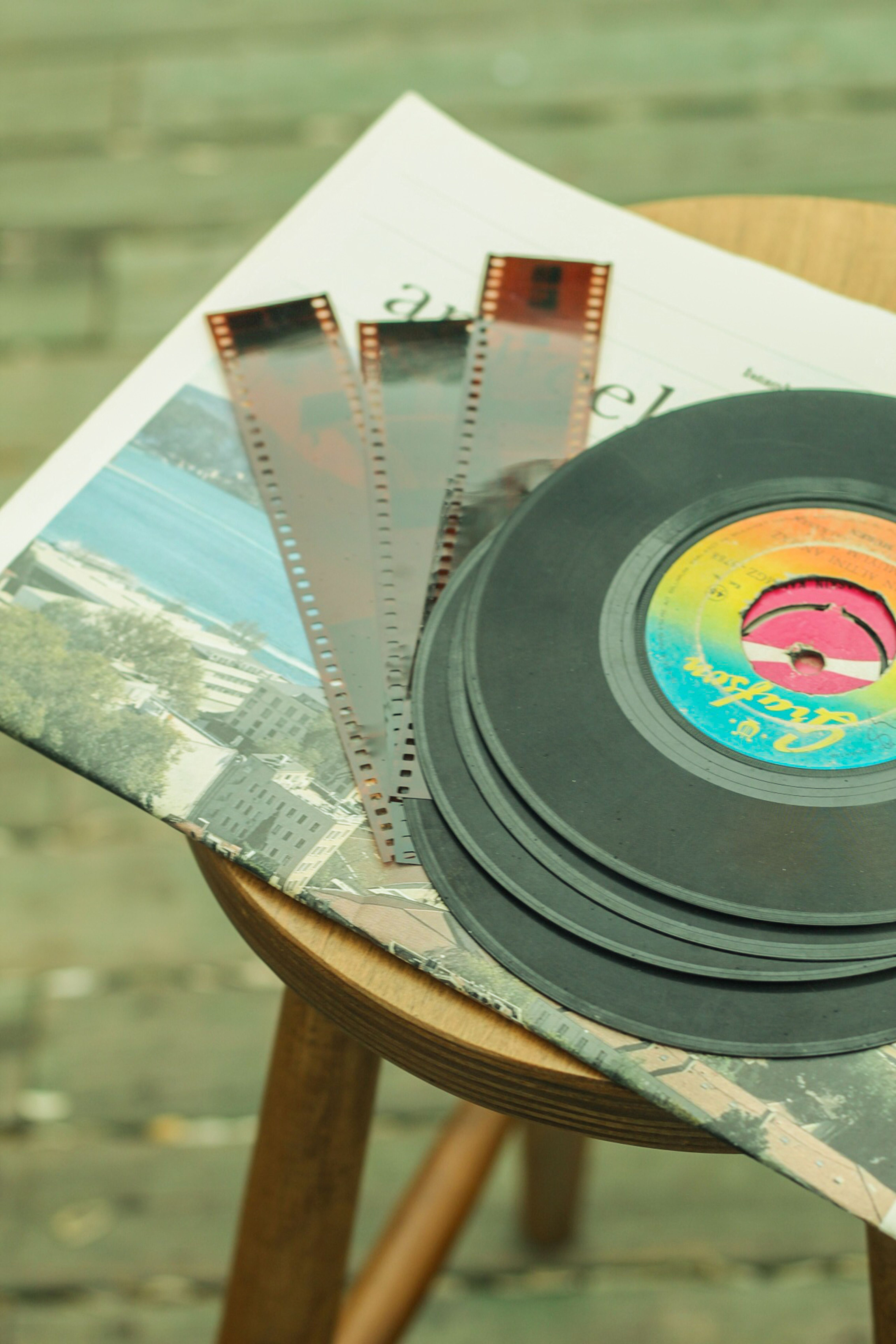 Vinyls and Camera Film on a Chair · Free Stock Photo