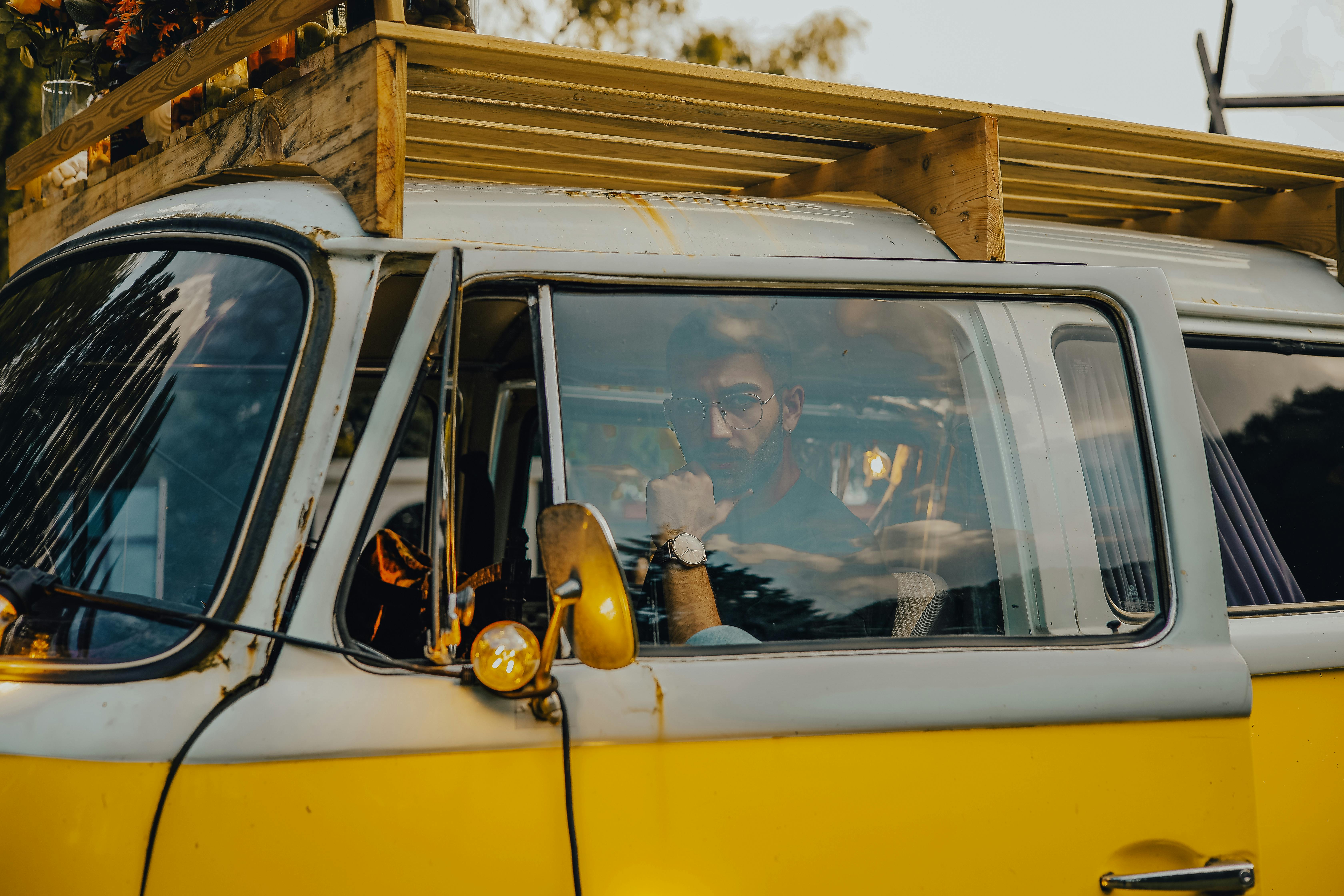 Man Sitting in a Vintage Van · Free Stock Photo