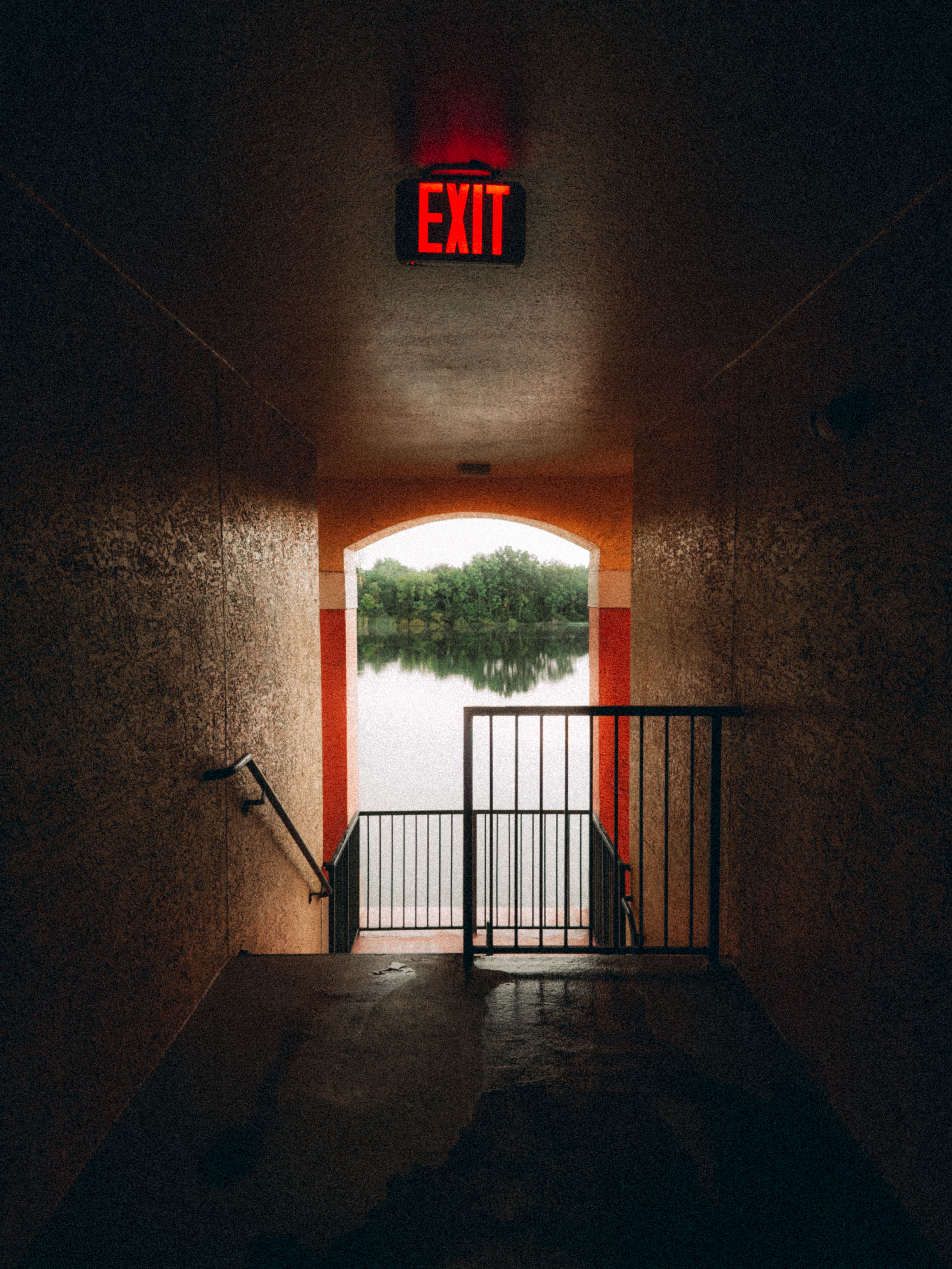 Dark Hallway with an Exit Sign · Free Stock Photo