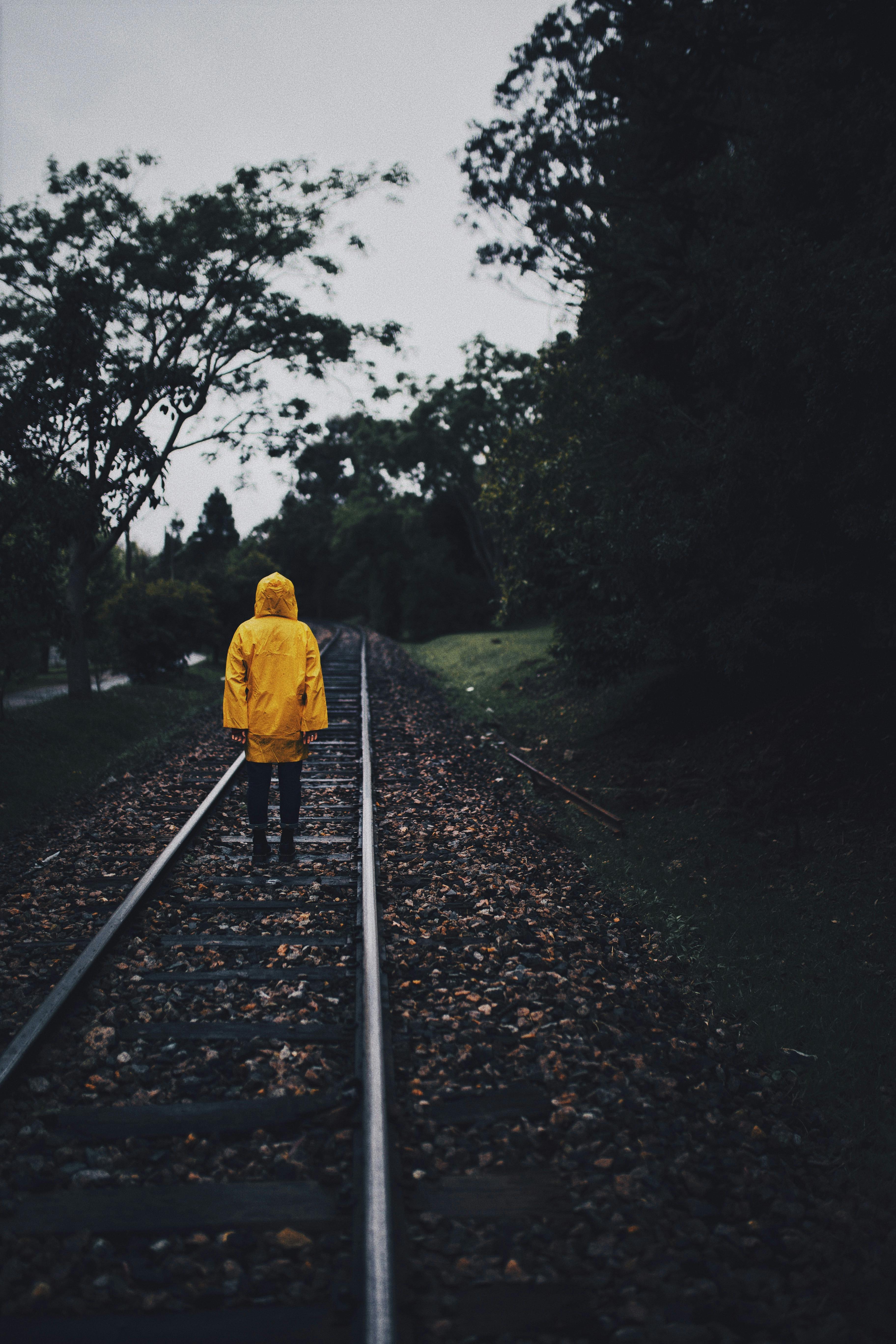 Person Standing on Train Rail · Free Stock Photo