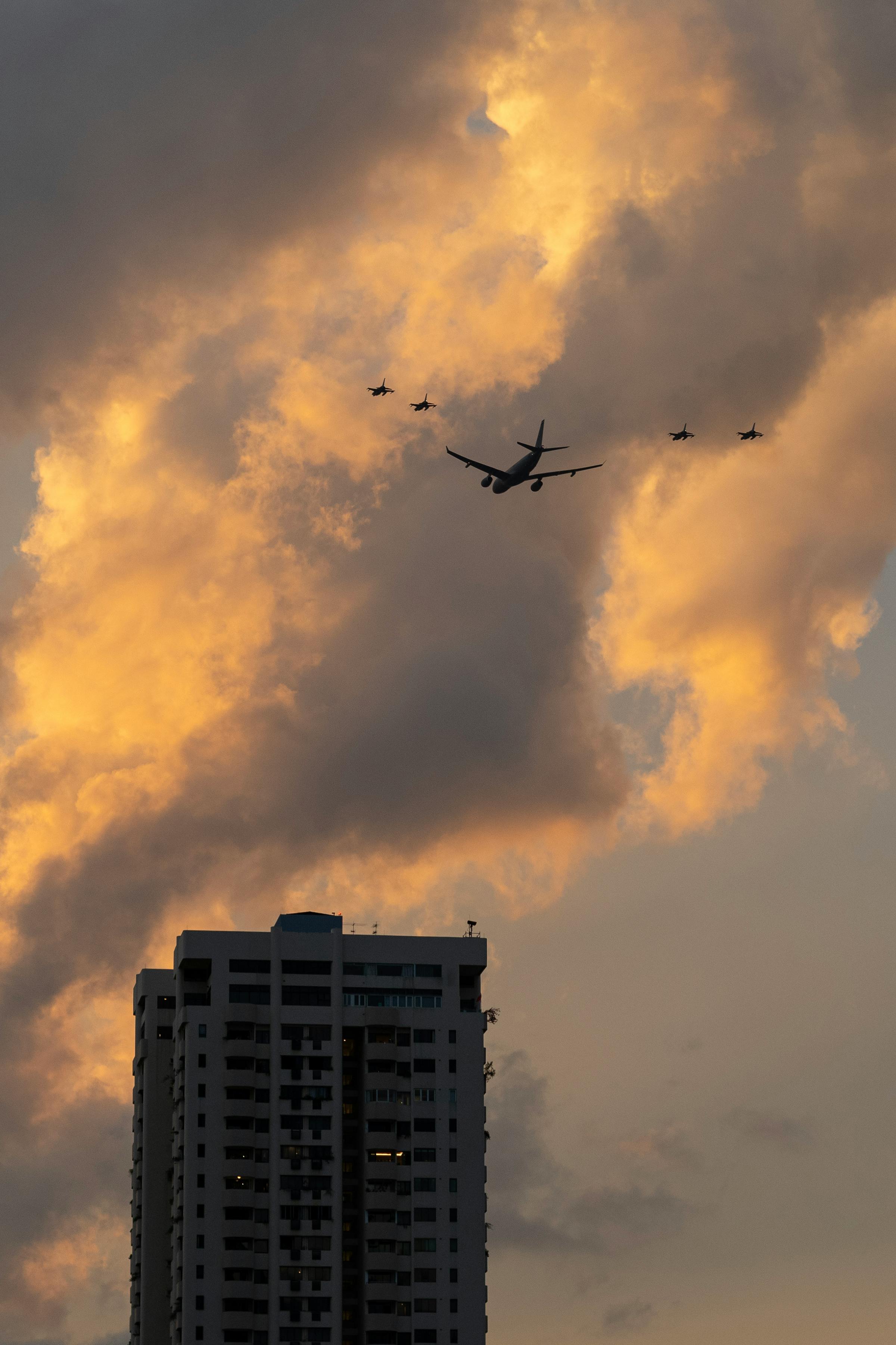 Airplane over Building at Sunset · Free Stock Photo