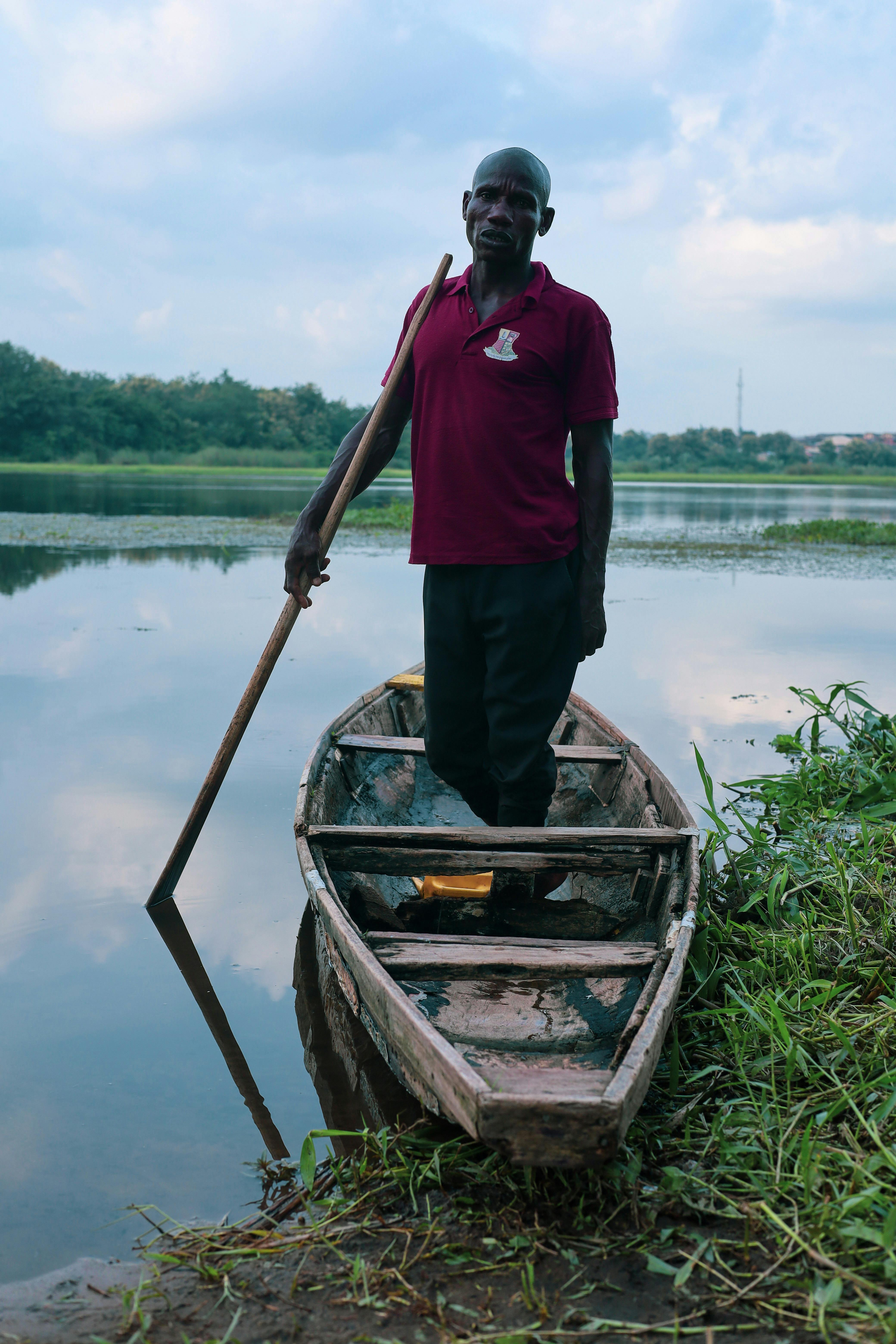 Man Standing on Wooden Boat · Free Stock Photo