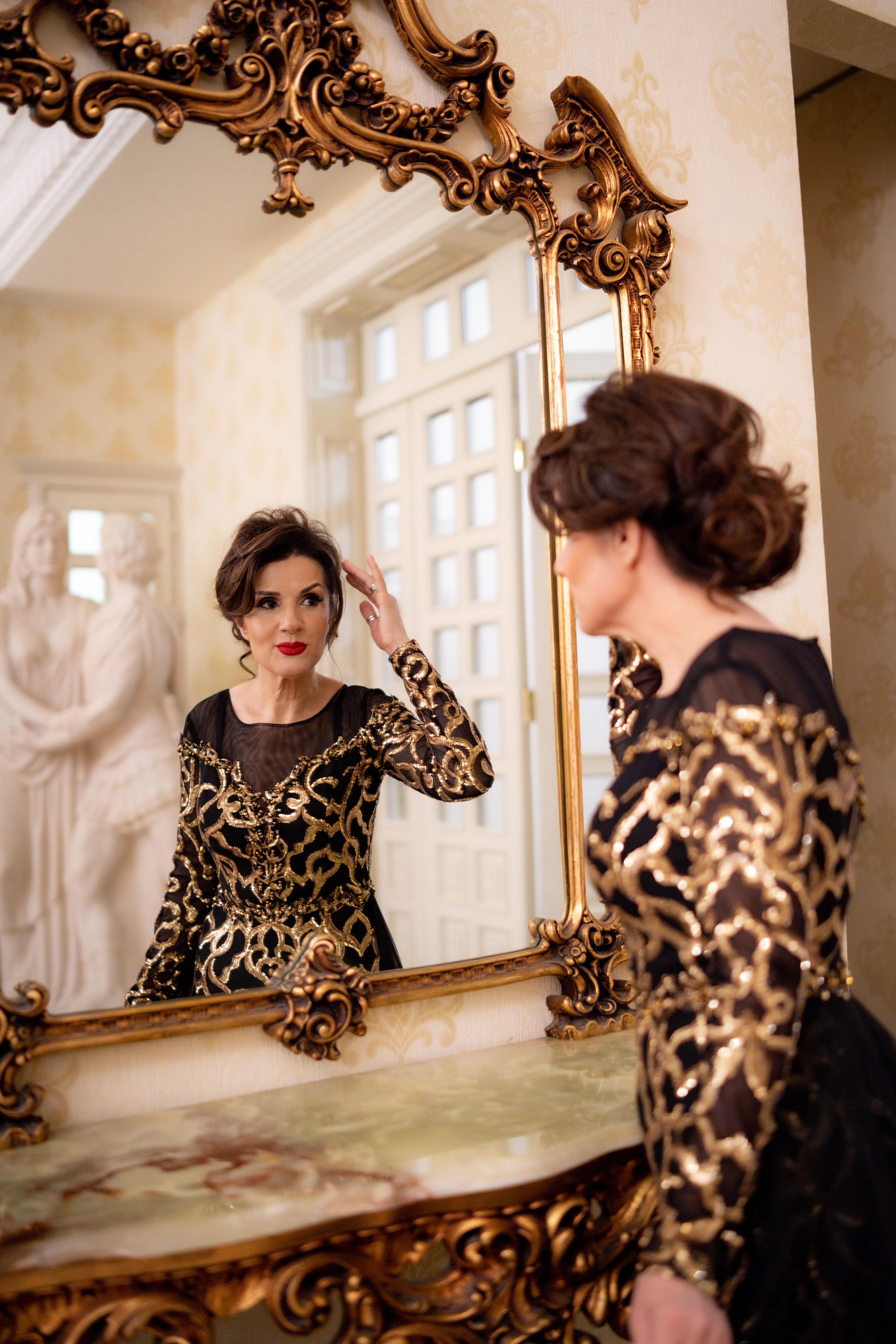 Reflection of Woman and Sculptures in Mirror · Free Stock Photo