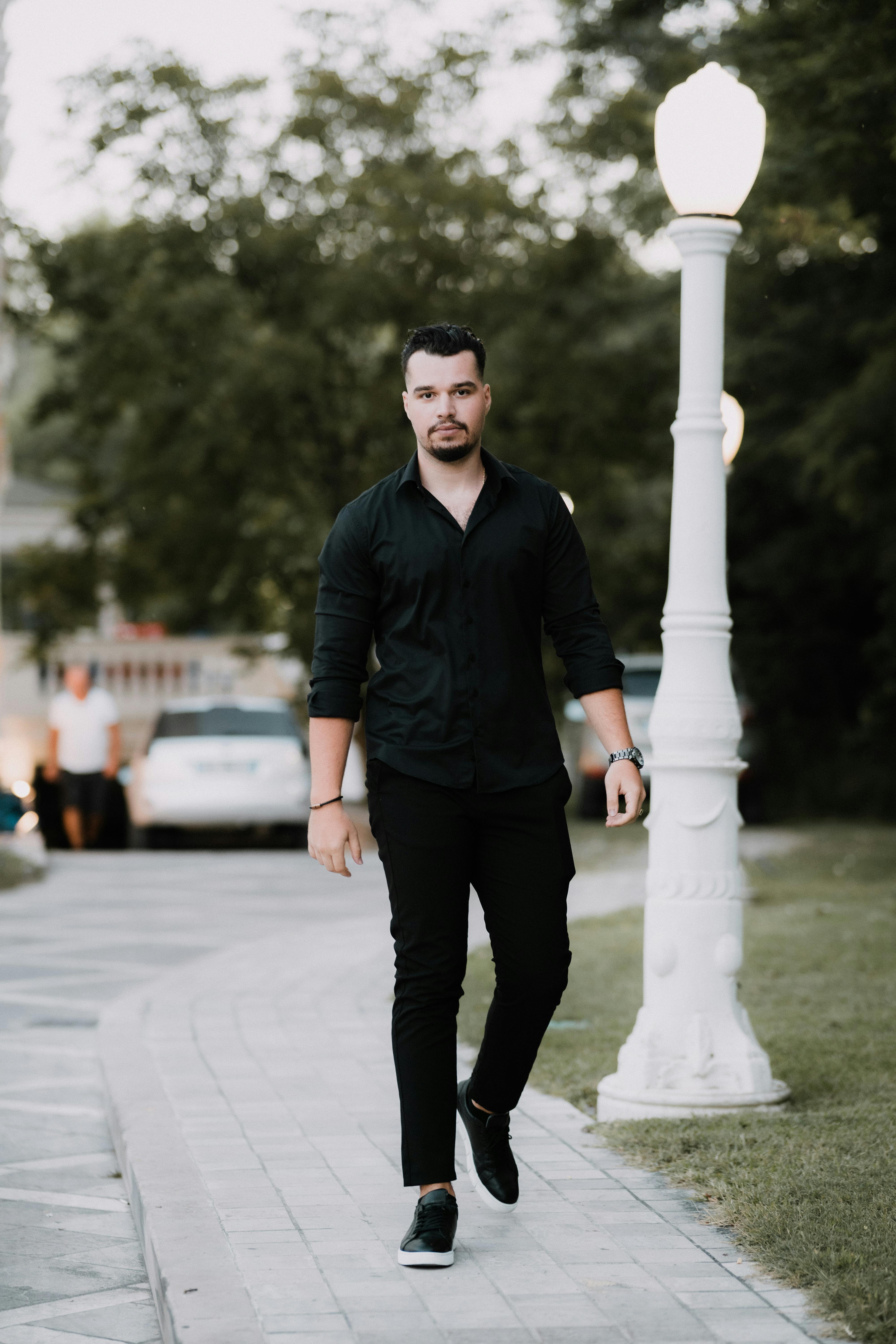 Man Walking on Sidewalk near Park · Free Stock Photo