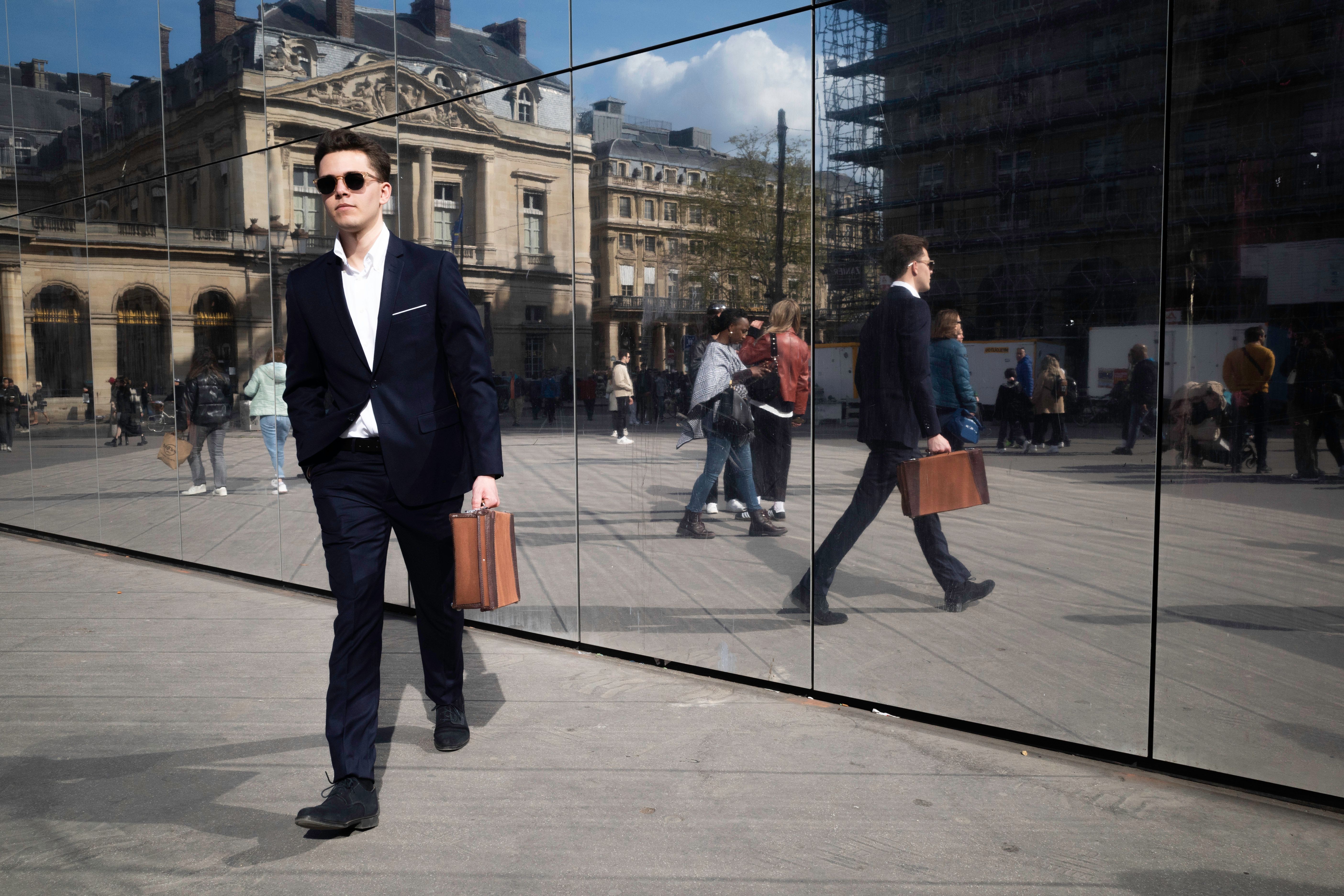 A Man in a Suit Reflecting in an Office Building · Free Stock Photo