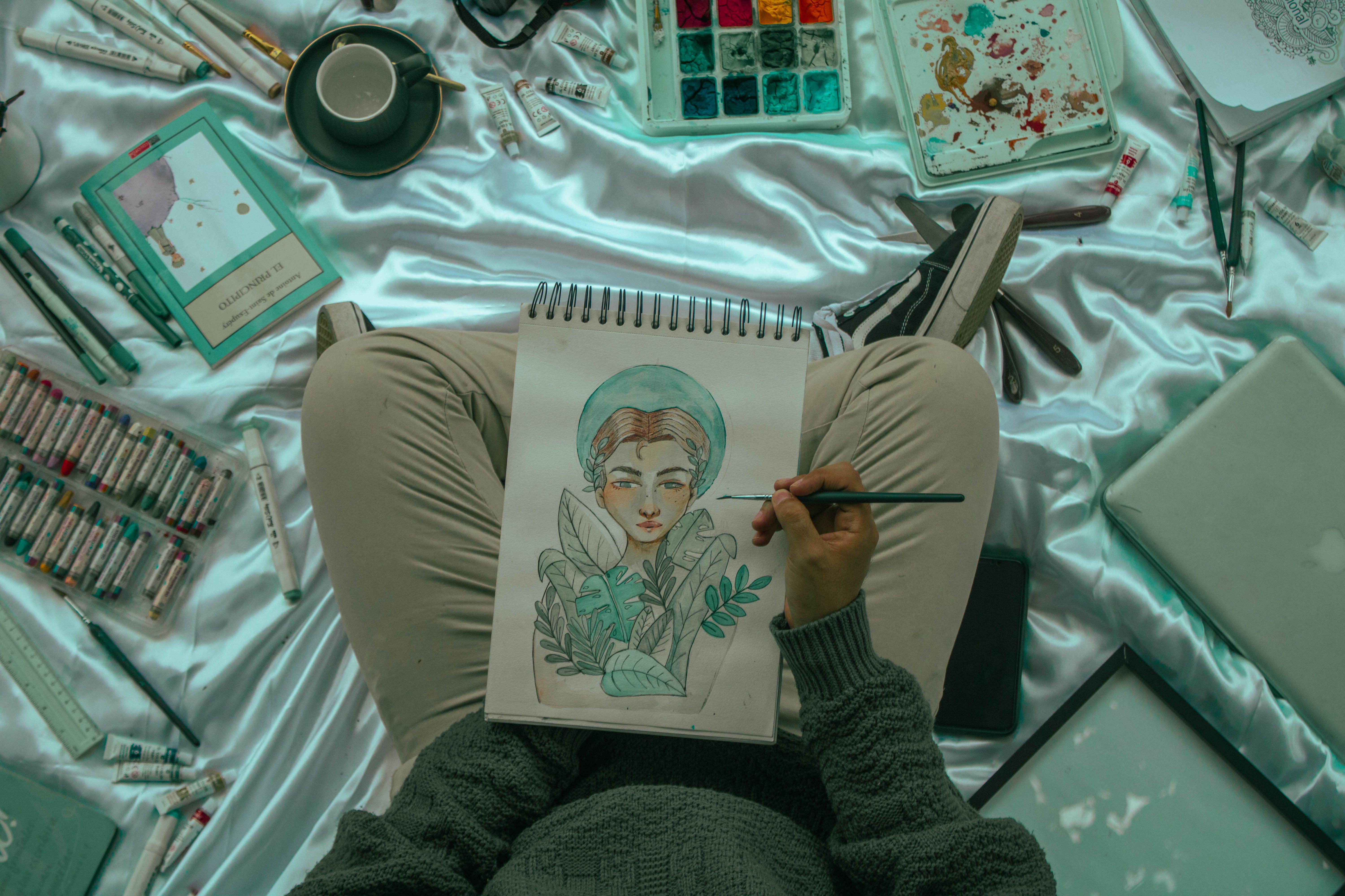 Hand of Person Painting in Notebook · Free Stock Photo
