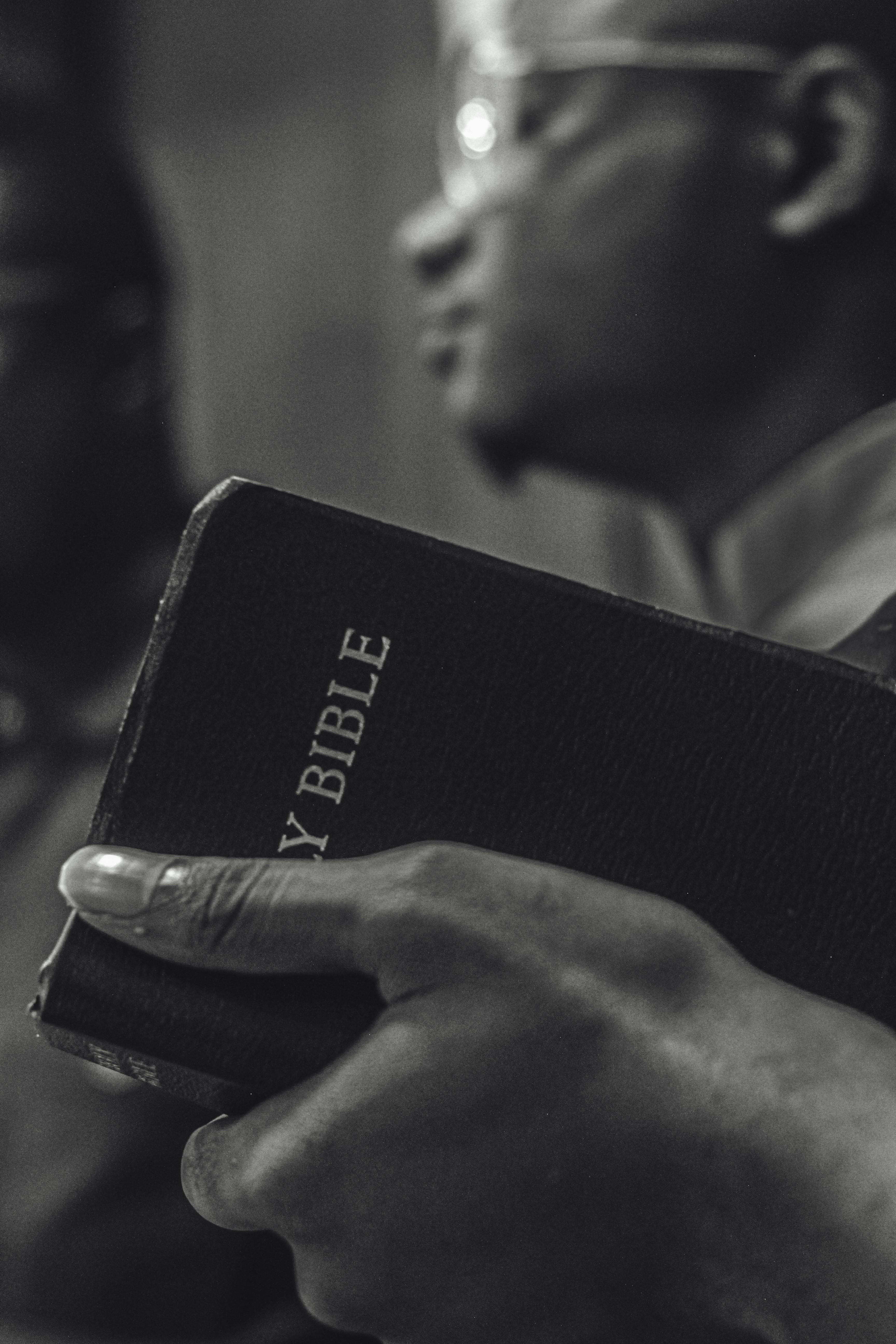Selective Focus Photography of Man Holding Bible · Free Stock Photo