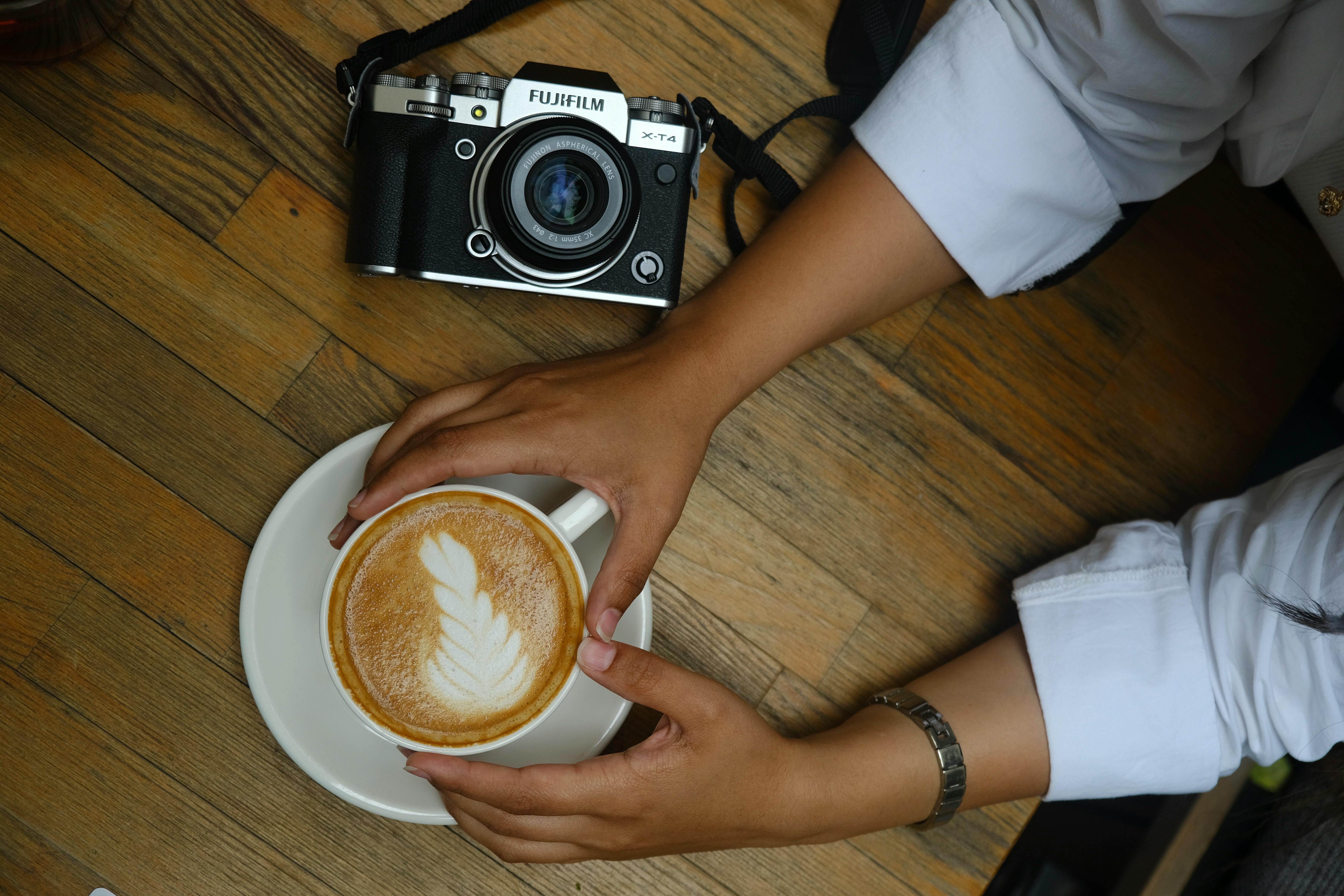 Woman with Coffee and Camera · Free Stock Photo