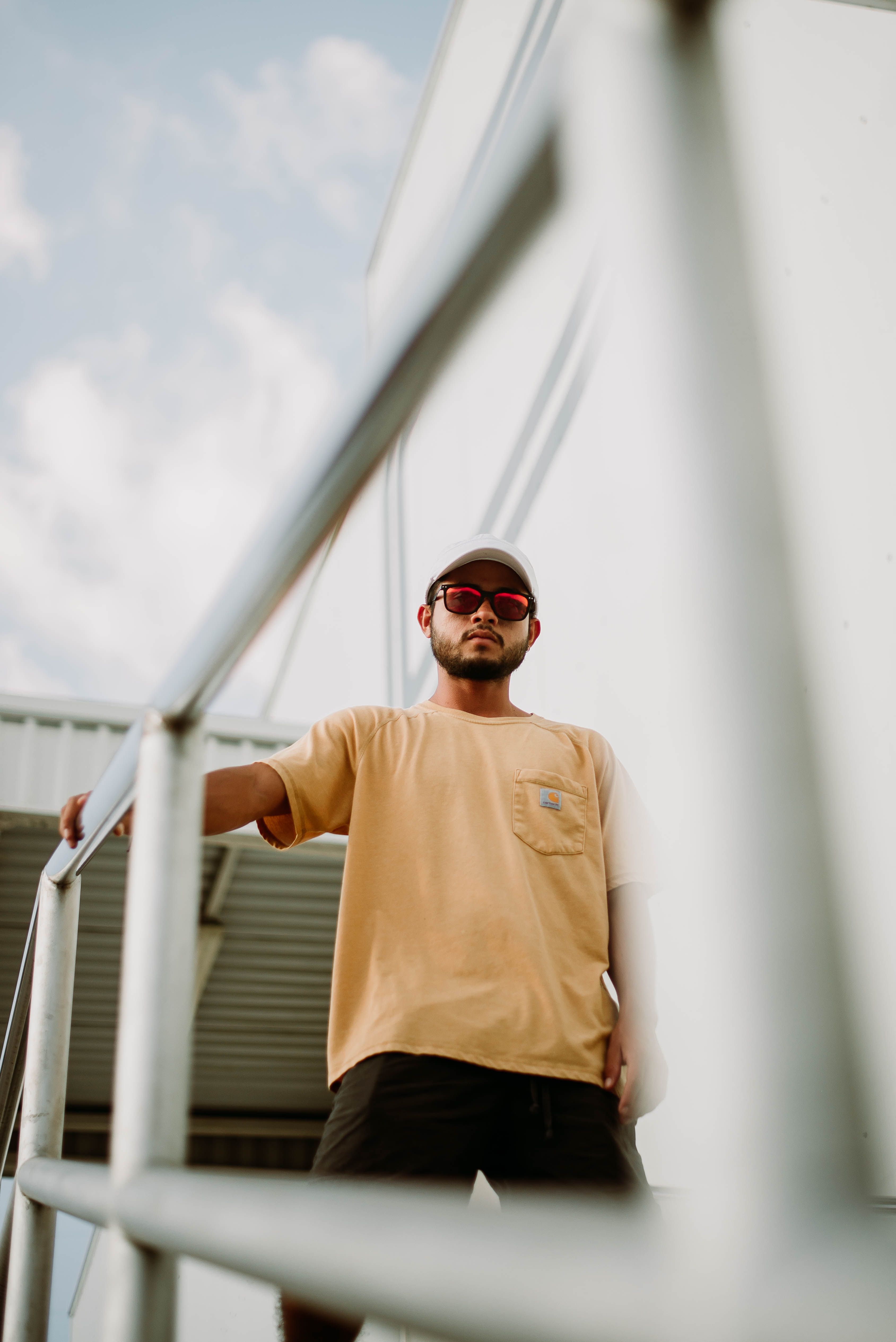 Low Angle Shot of a Man Standing on the Steps · Free Stock Photo